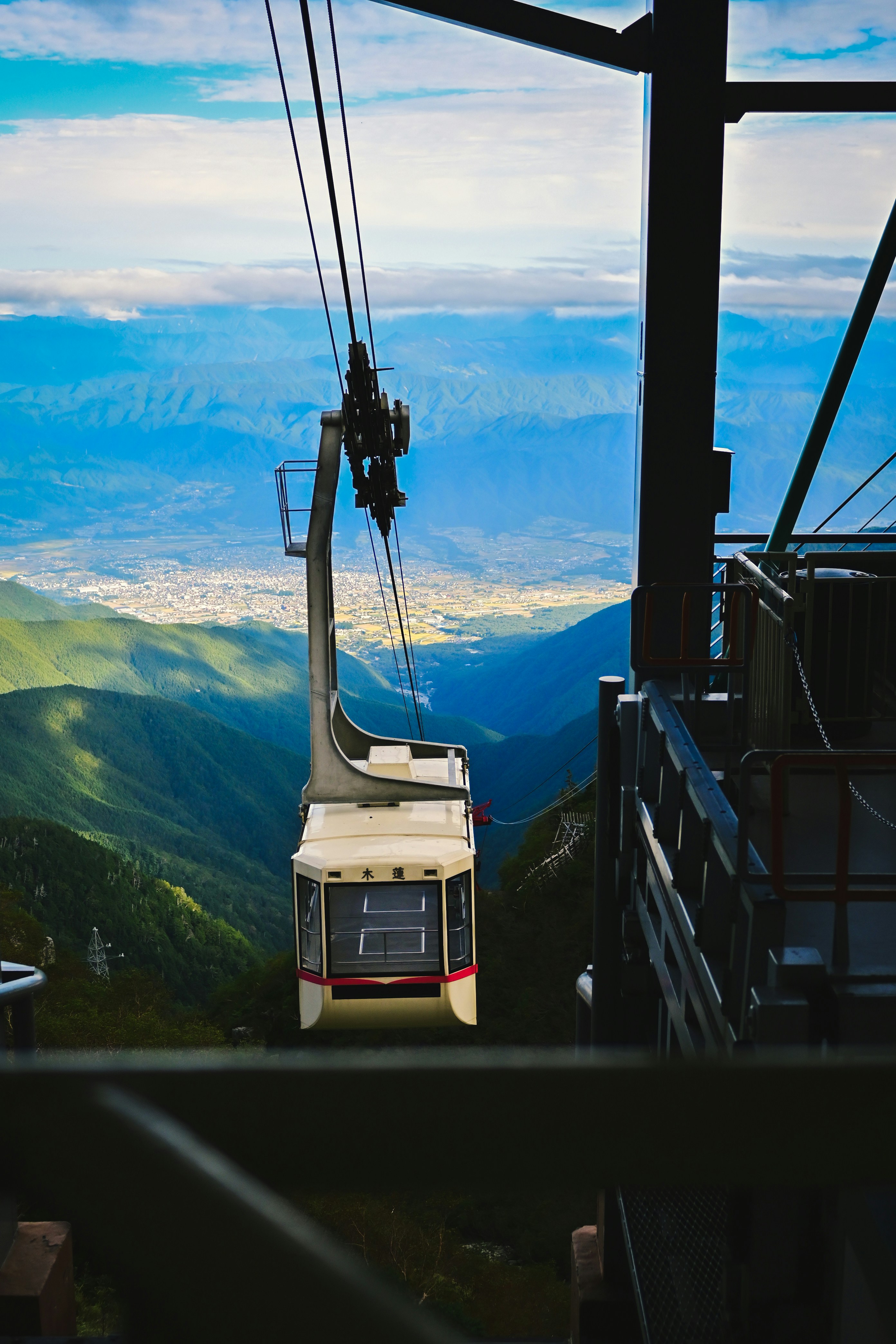A cable car going up a hill with mountains in the background photo ...
