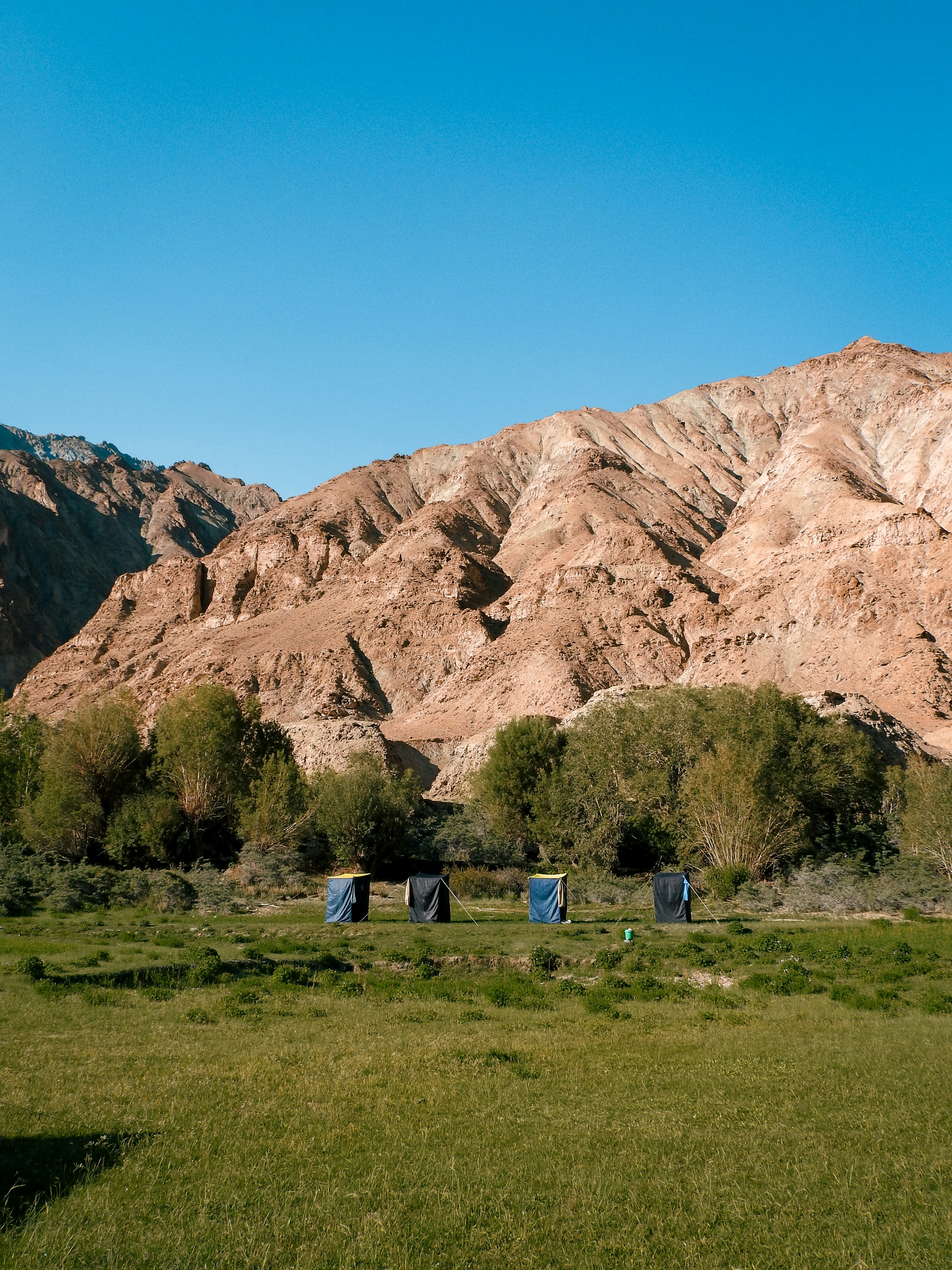 Campground Under Red Ridge: Tents at the Foot of Desert Cliffs