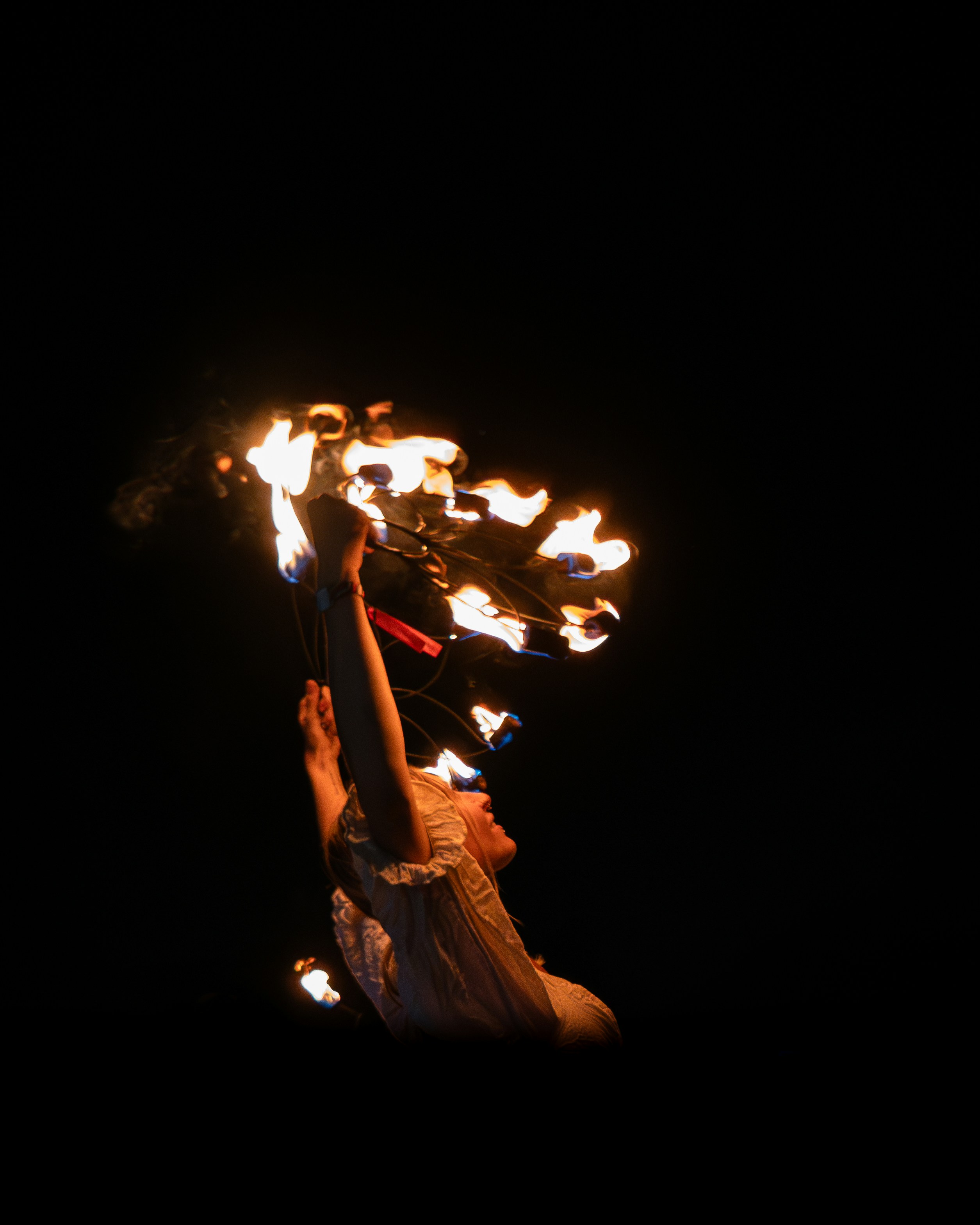 A person holding a fire stick in the dark photo – Free Woman Image on ...