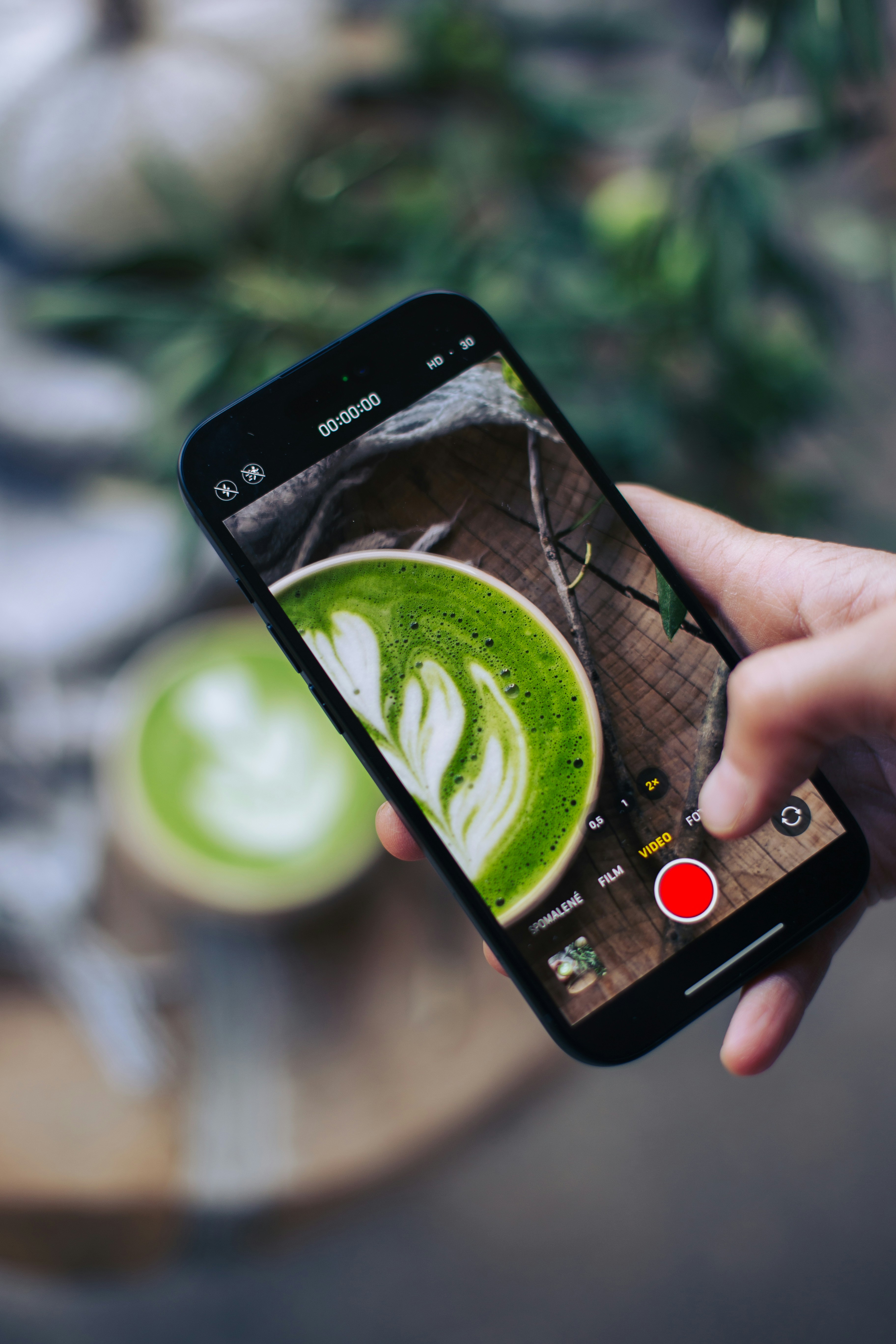 A person taking a picture with a cell phone photo – Free Matcha Image ...