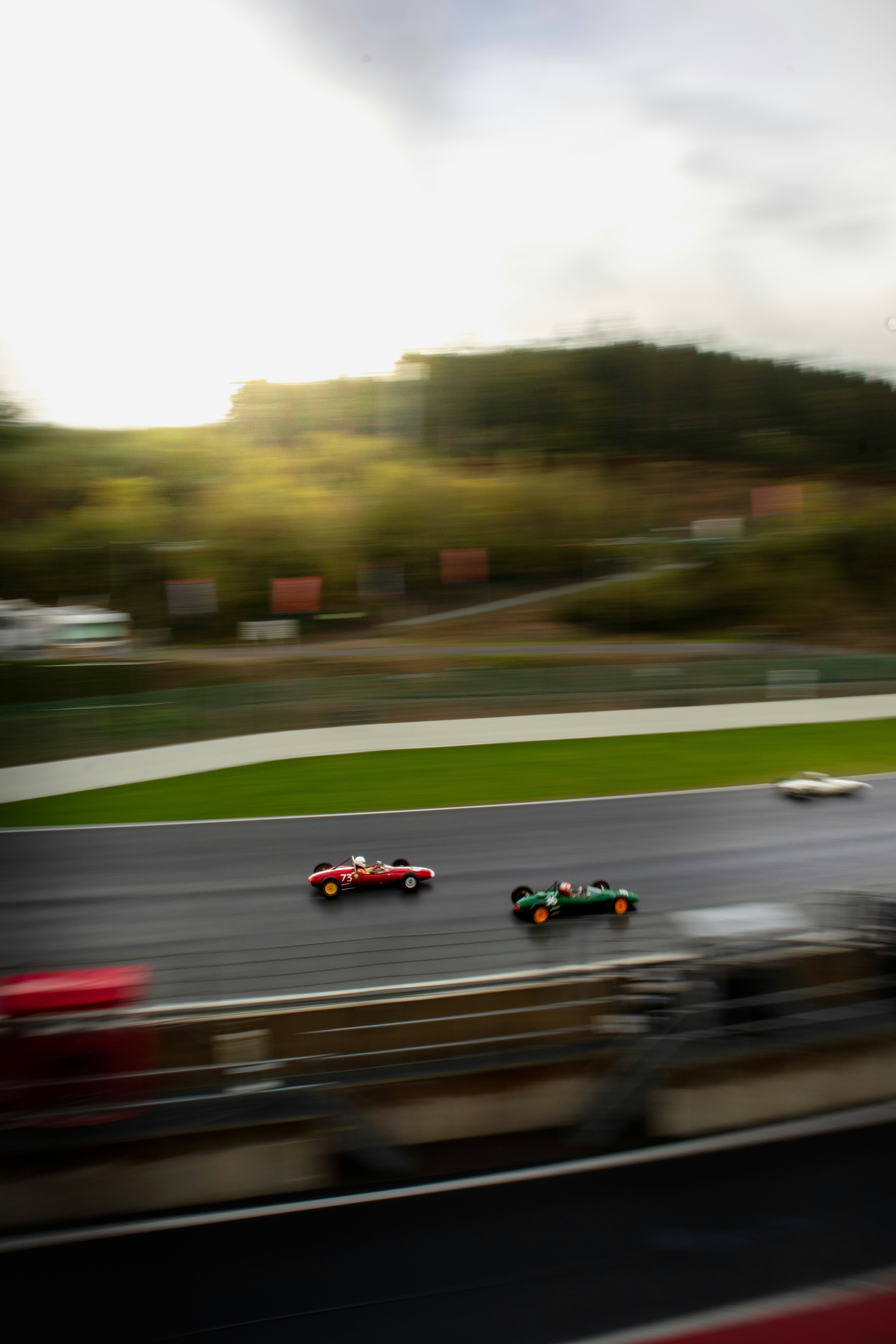 A blurry photo of a race track with cars on it photo – Free Background ...