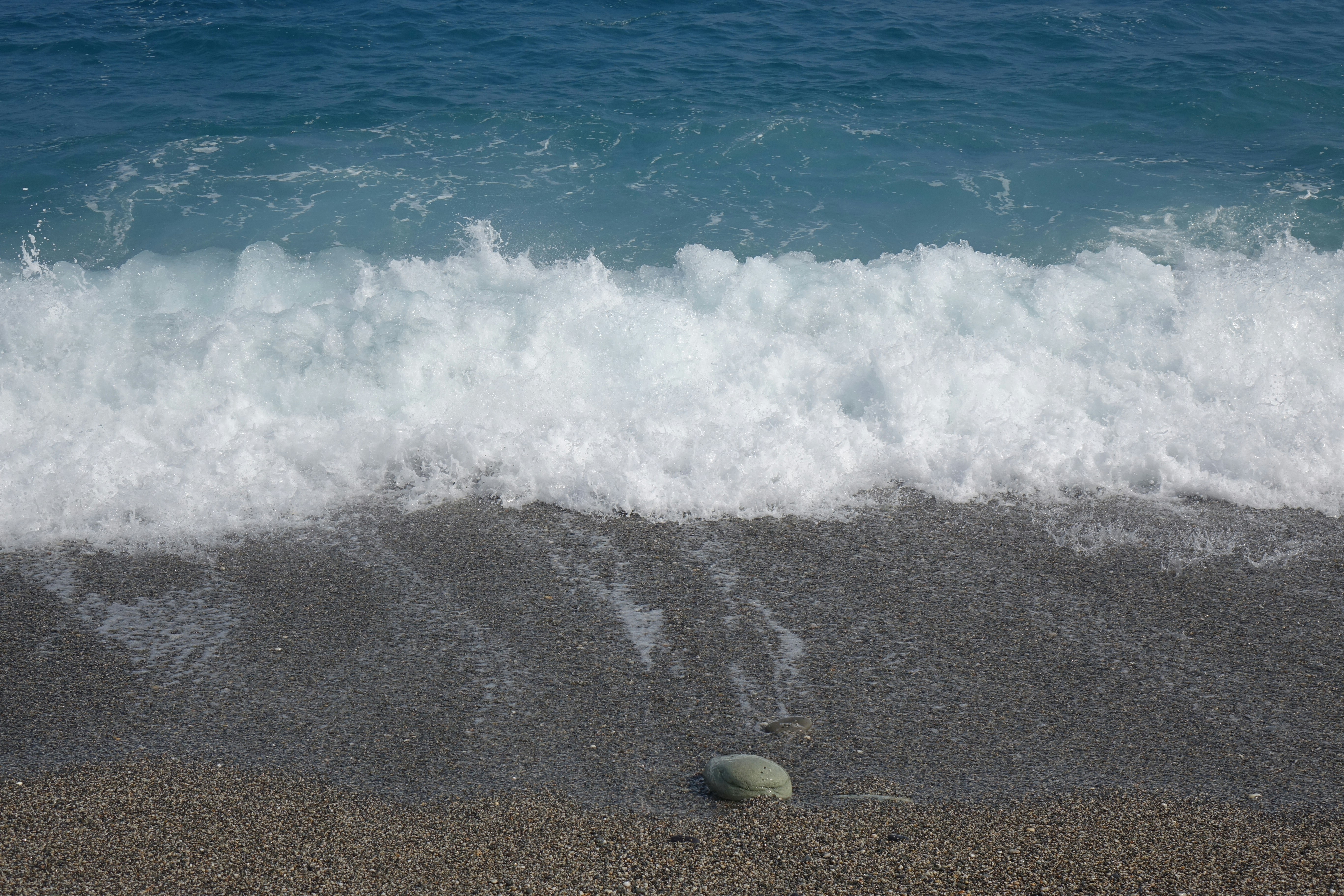 Pebble at the Edge: Quiet Tide on a Pebbled Beach