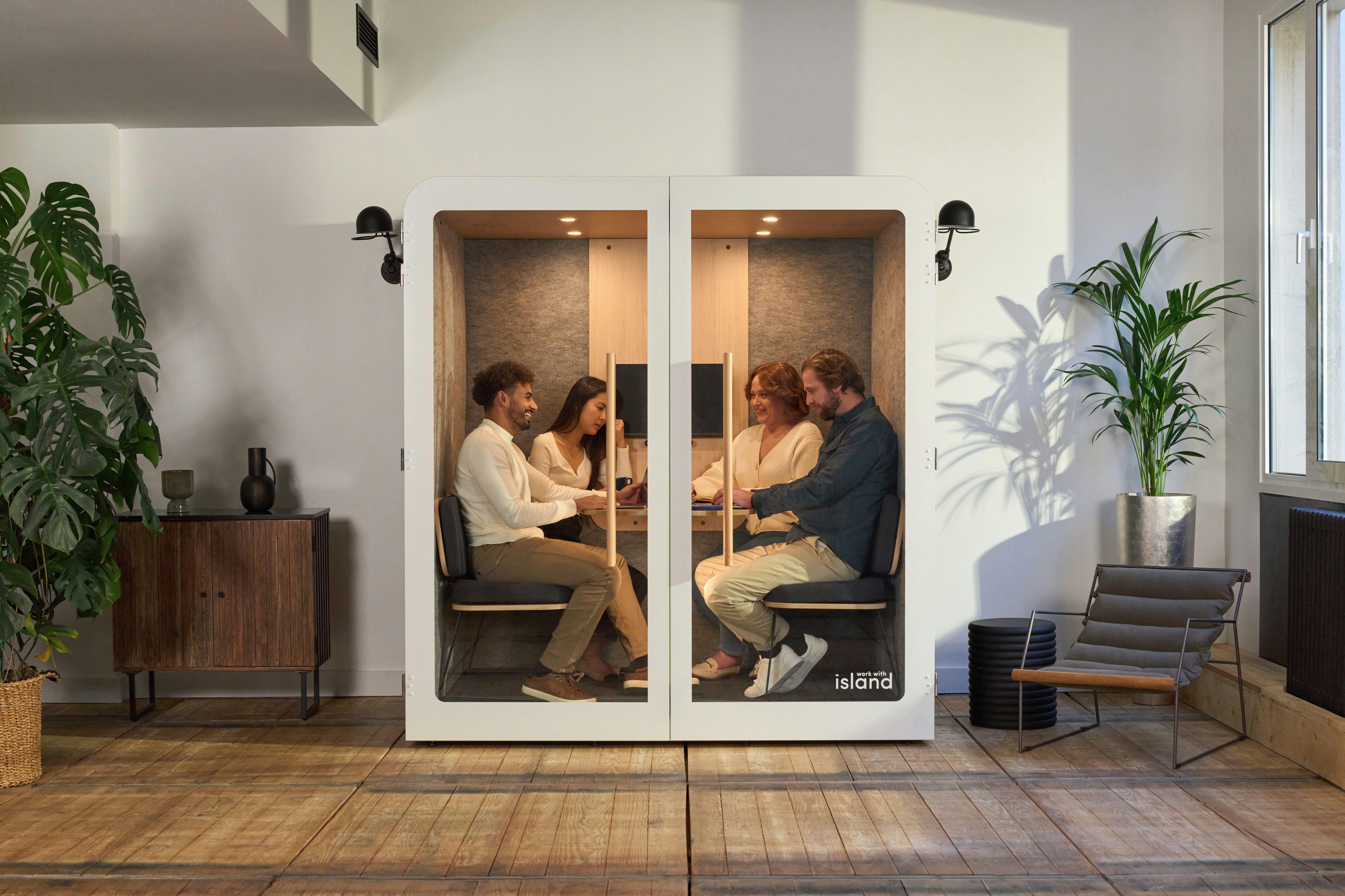 People working People working on a meeting pod Startup | A couple of people sitting in a room