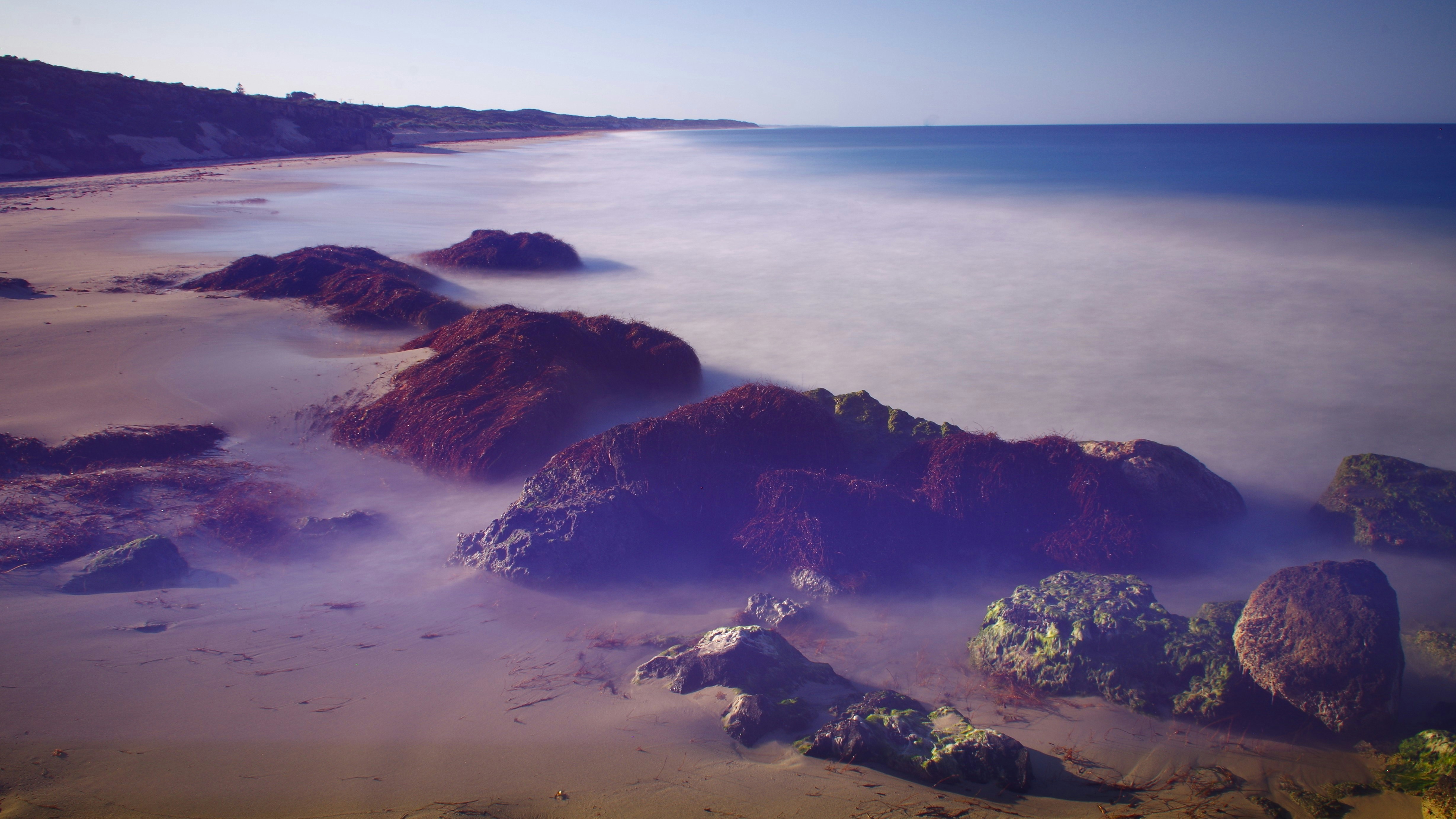 A view of a beach with rocks and water photo – Free Two rocks wa Image ...