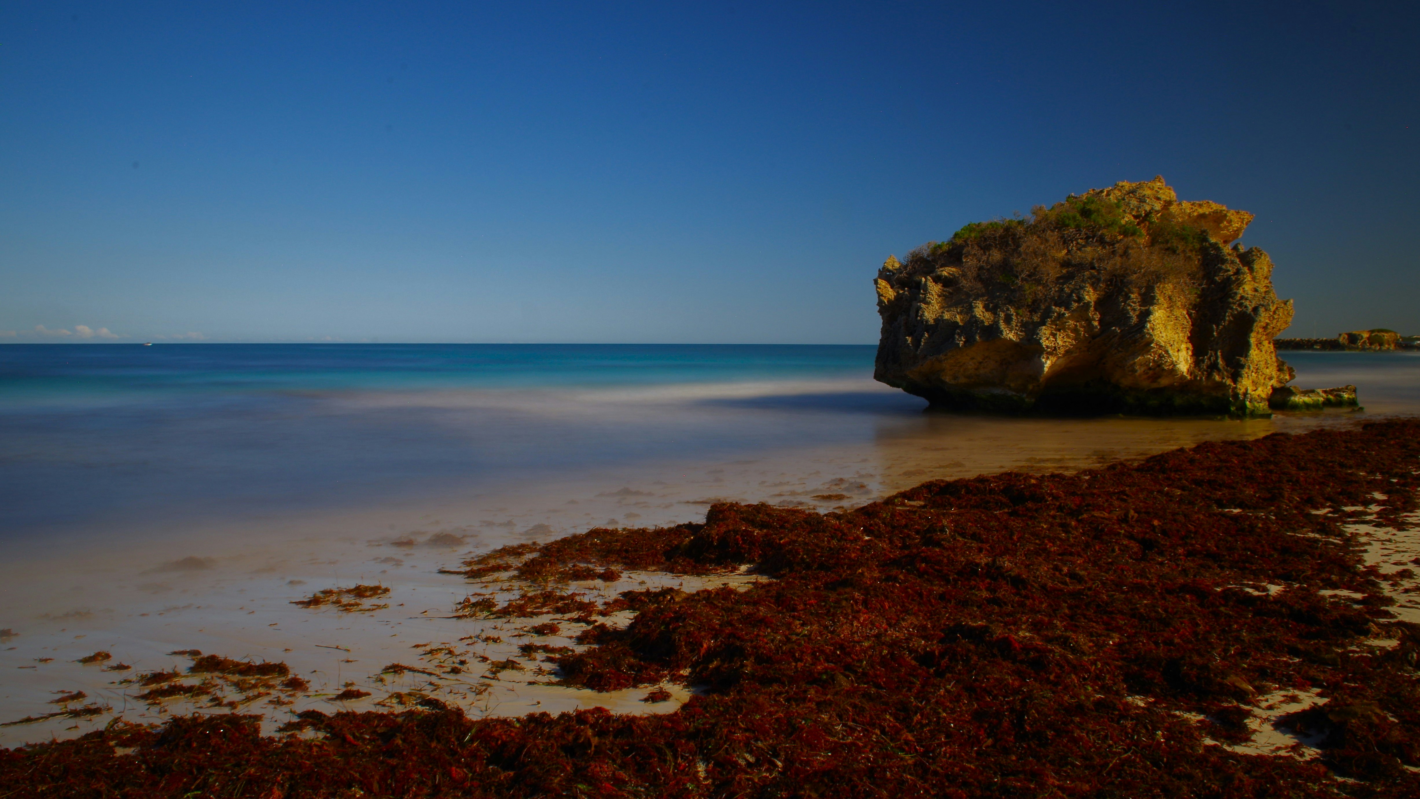 A large rock sticking out of the ocean photo – Free Two rocks wa Image ...