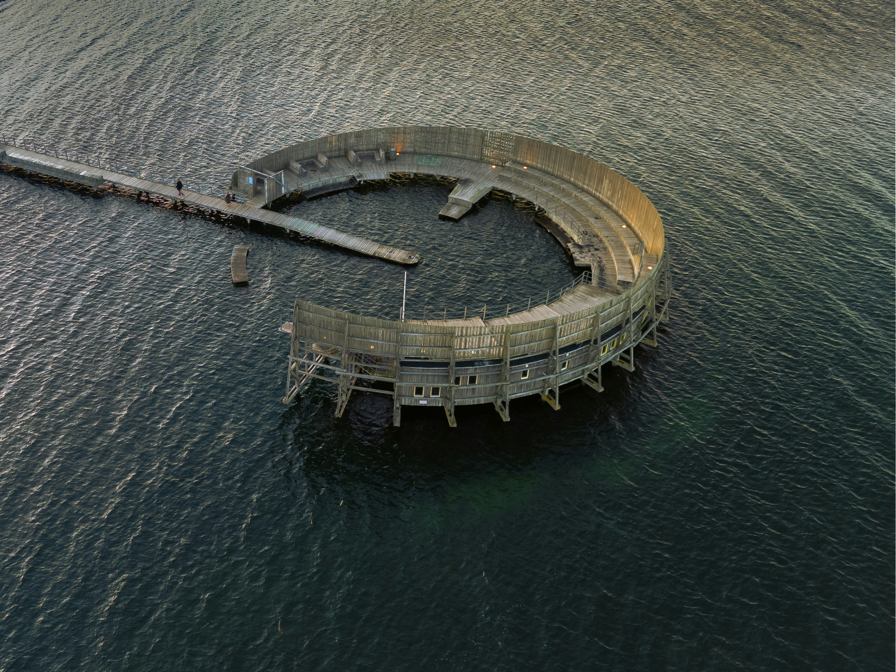 Ringed by Waves: Aerial View of a Circular Pier Framing the Sea