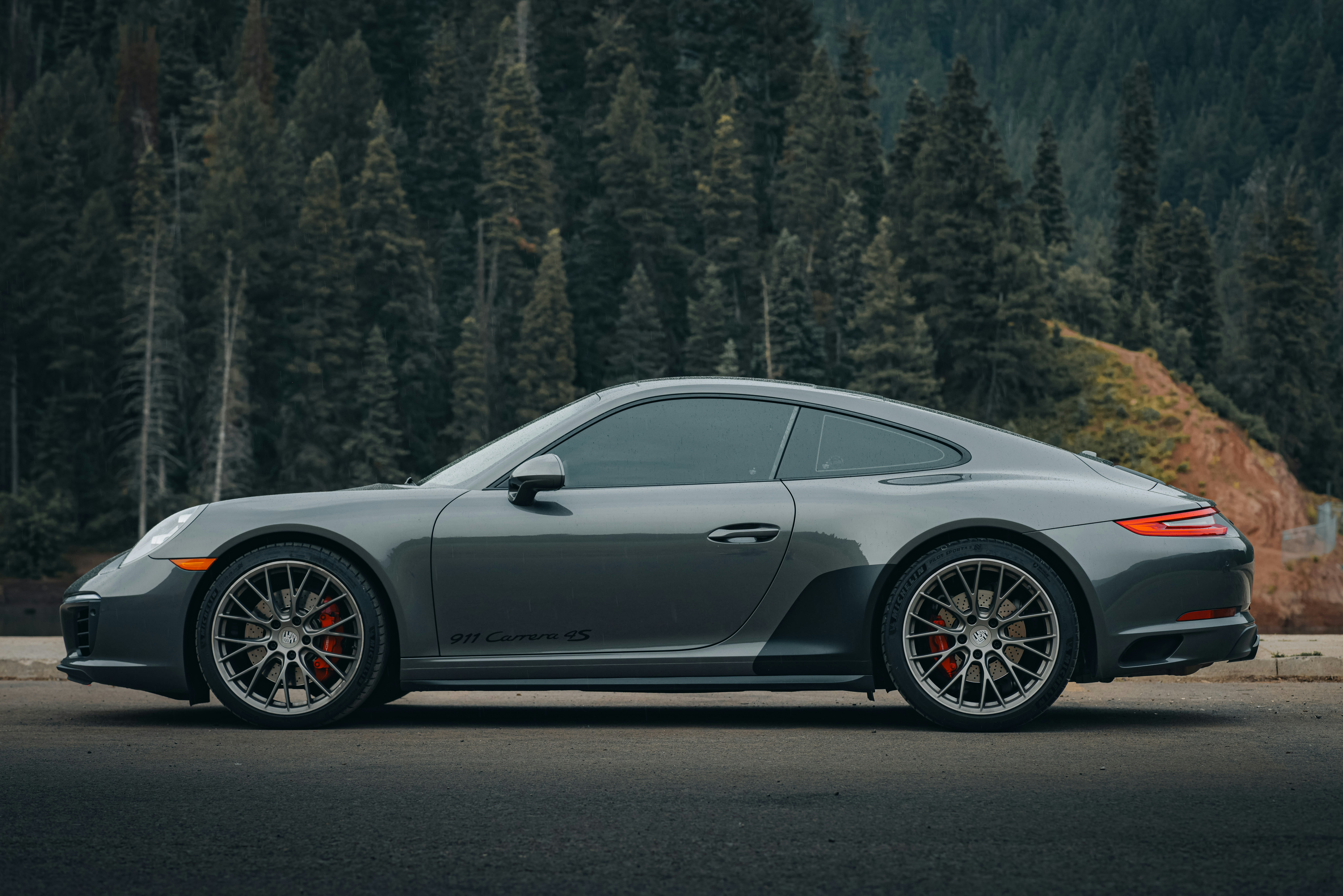 A grey sports car parked on the side of the road photo – Free Machine ...
