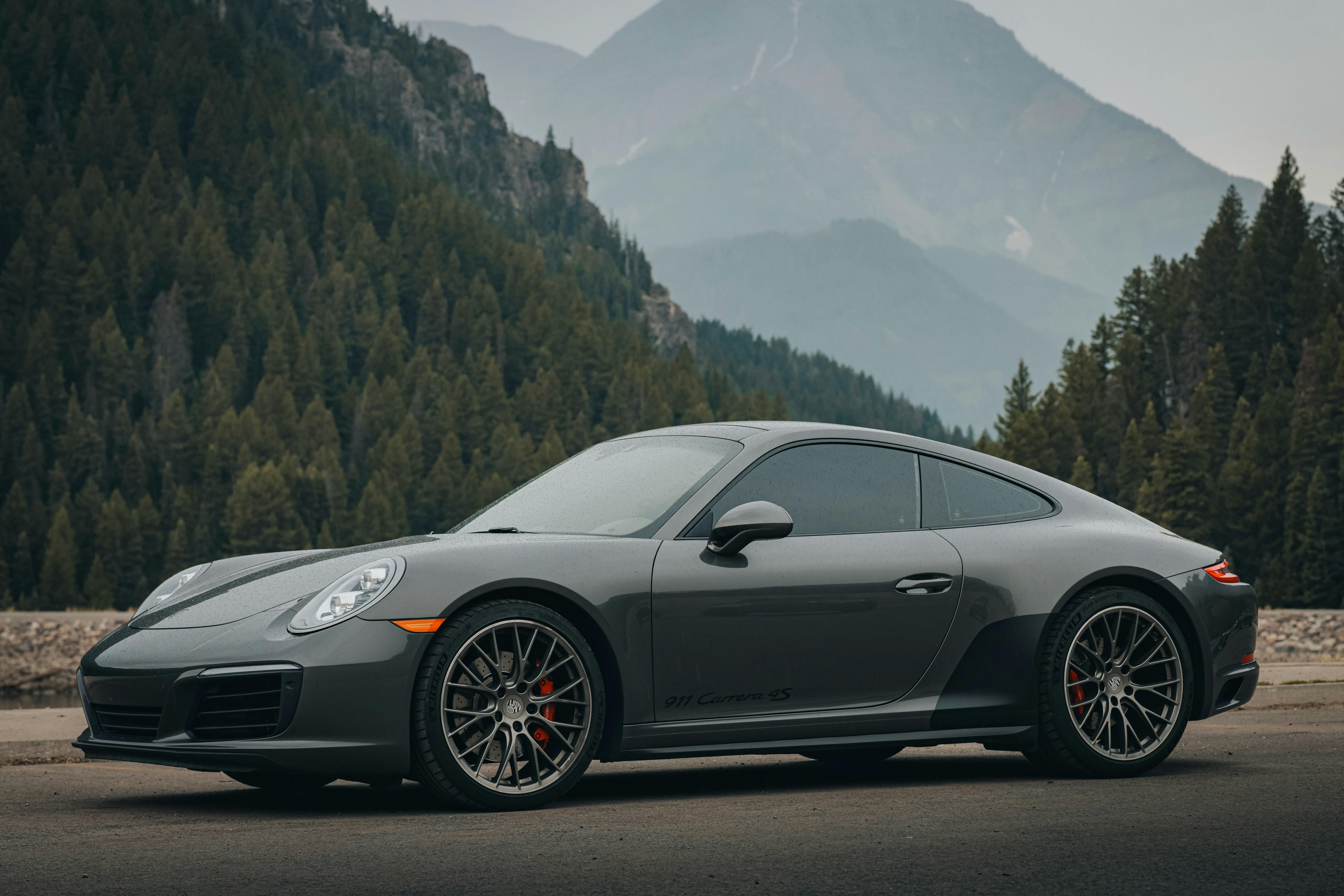A grey sports car parked in front of a mountain photo – Free Machine ...