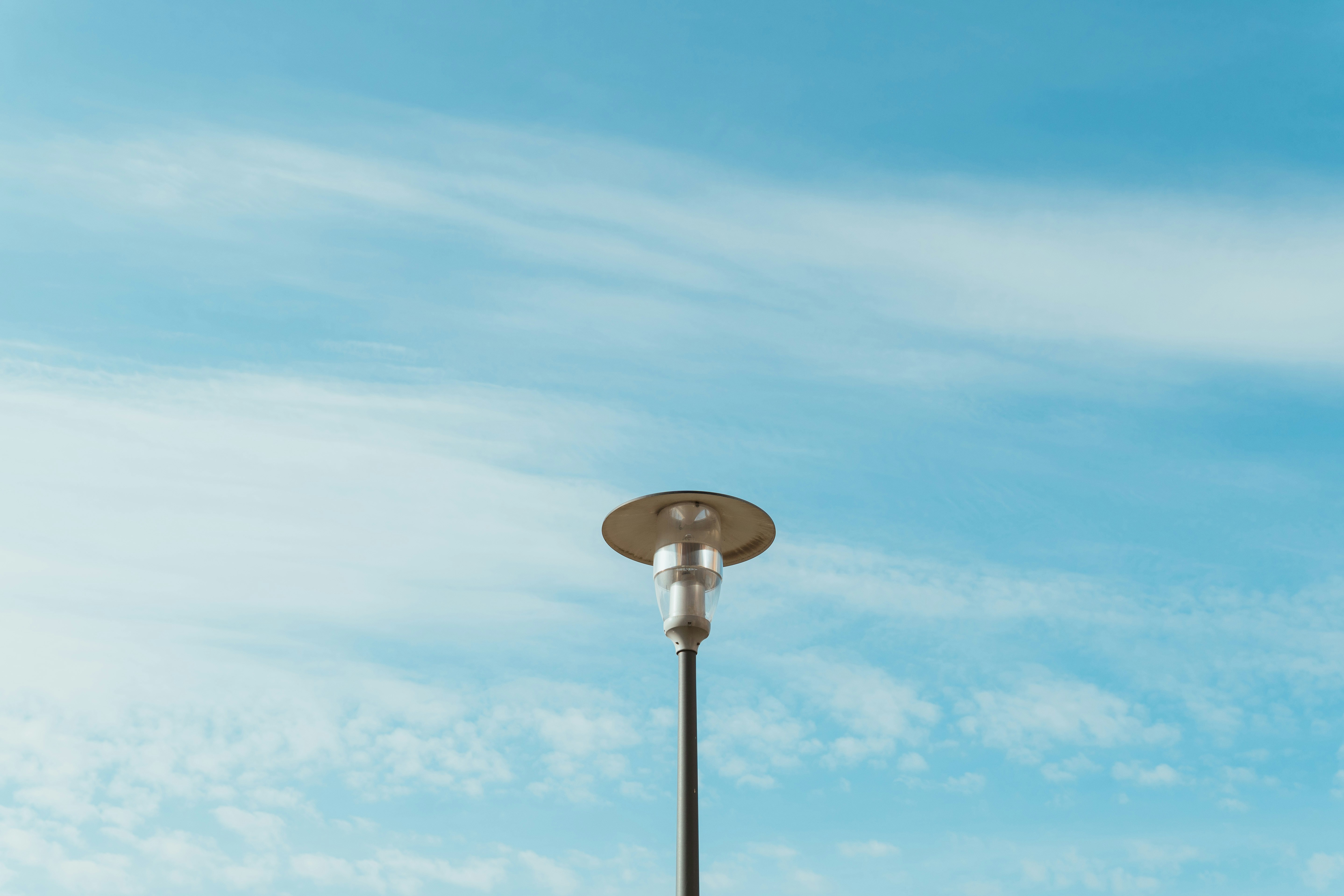 A street light sitting on the side of a road photo – Free Sky Image on ...