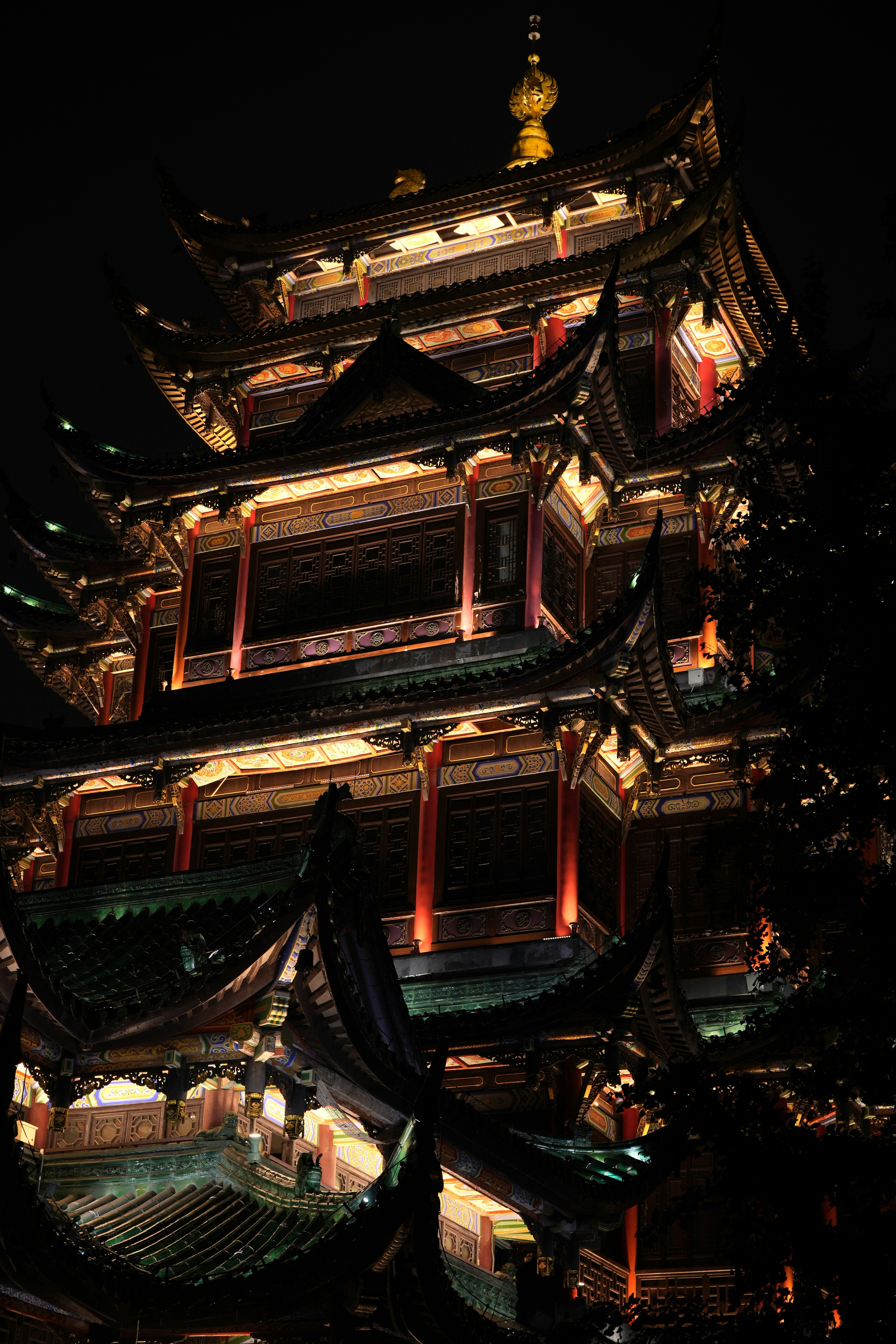 A tall building lit up at night time photo – Free China Image on Unsplash