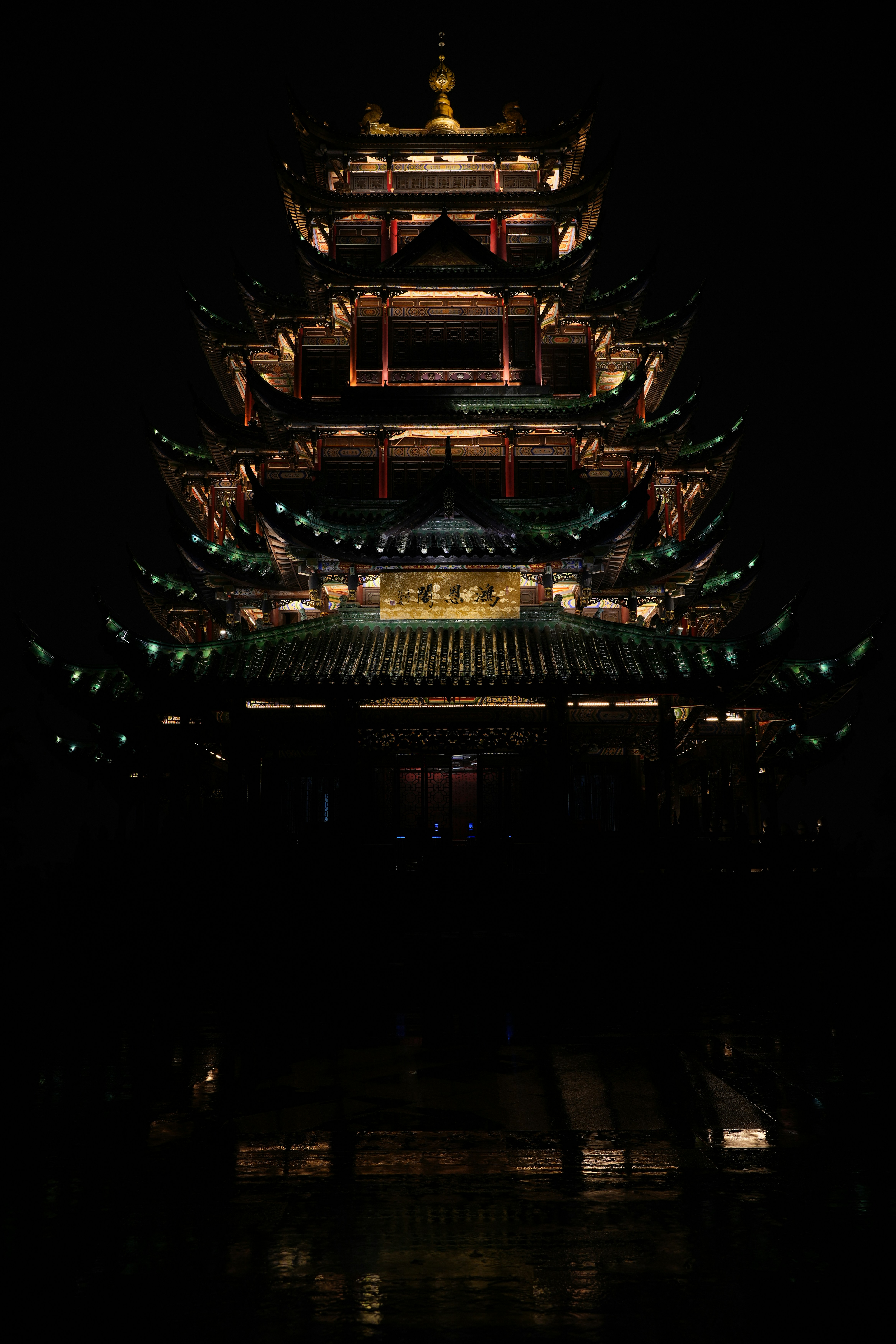 Moonlit Tiered Pagoda: Lantern-Crowned Summit Emerges from Night
