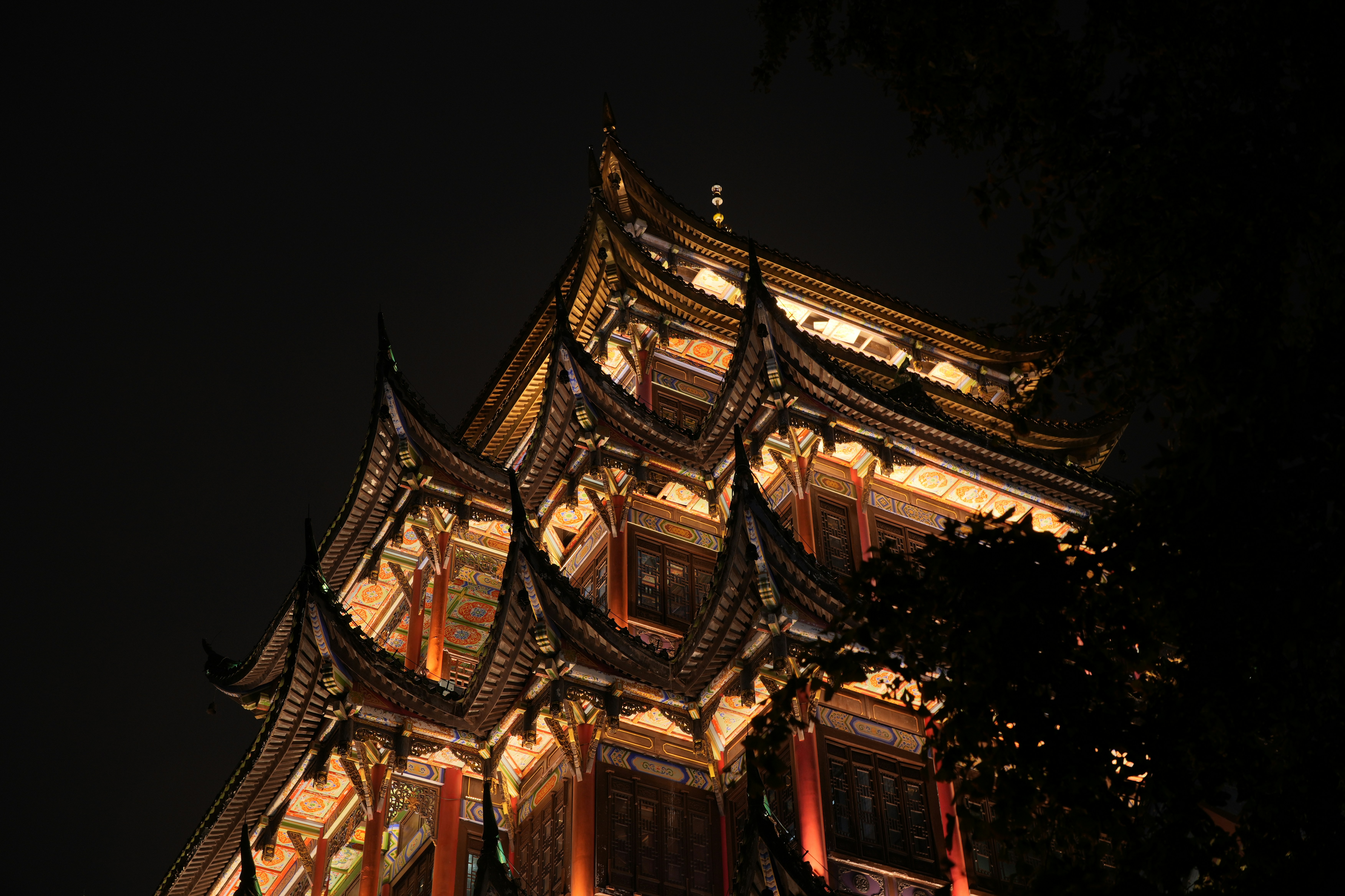 Lantern-lit tiers rise above a shadowed night
