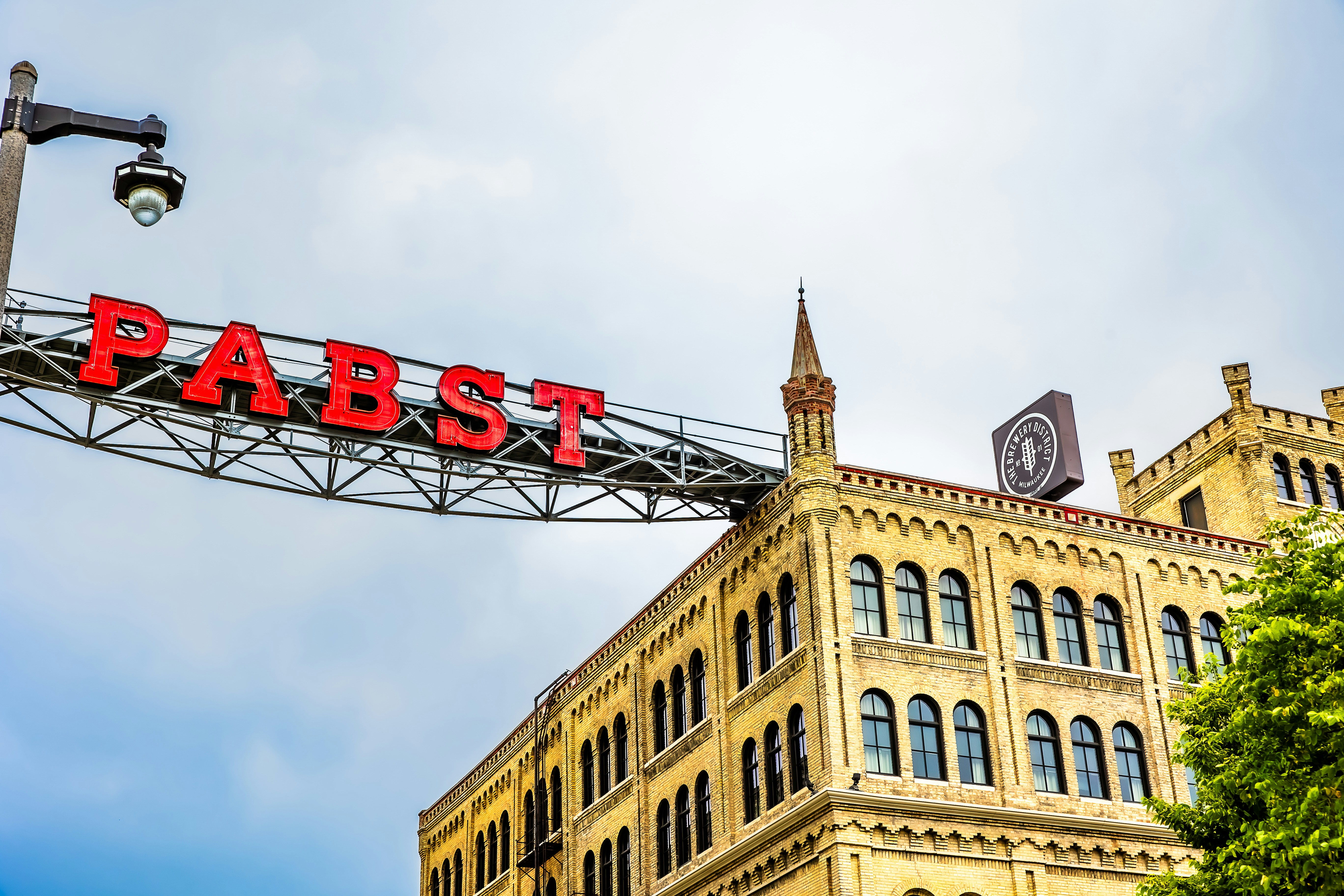 Red PABST Sign Crowned Over a Sunlit Brick Cityscape