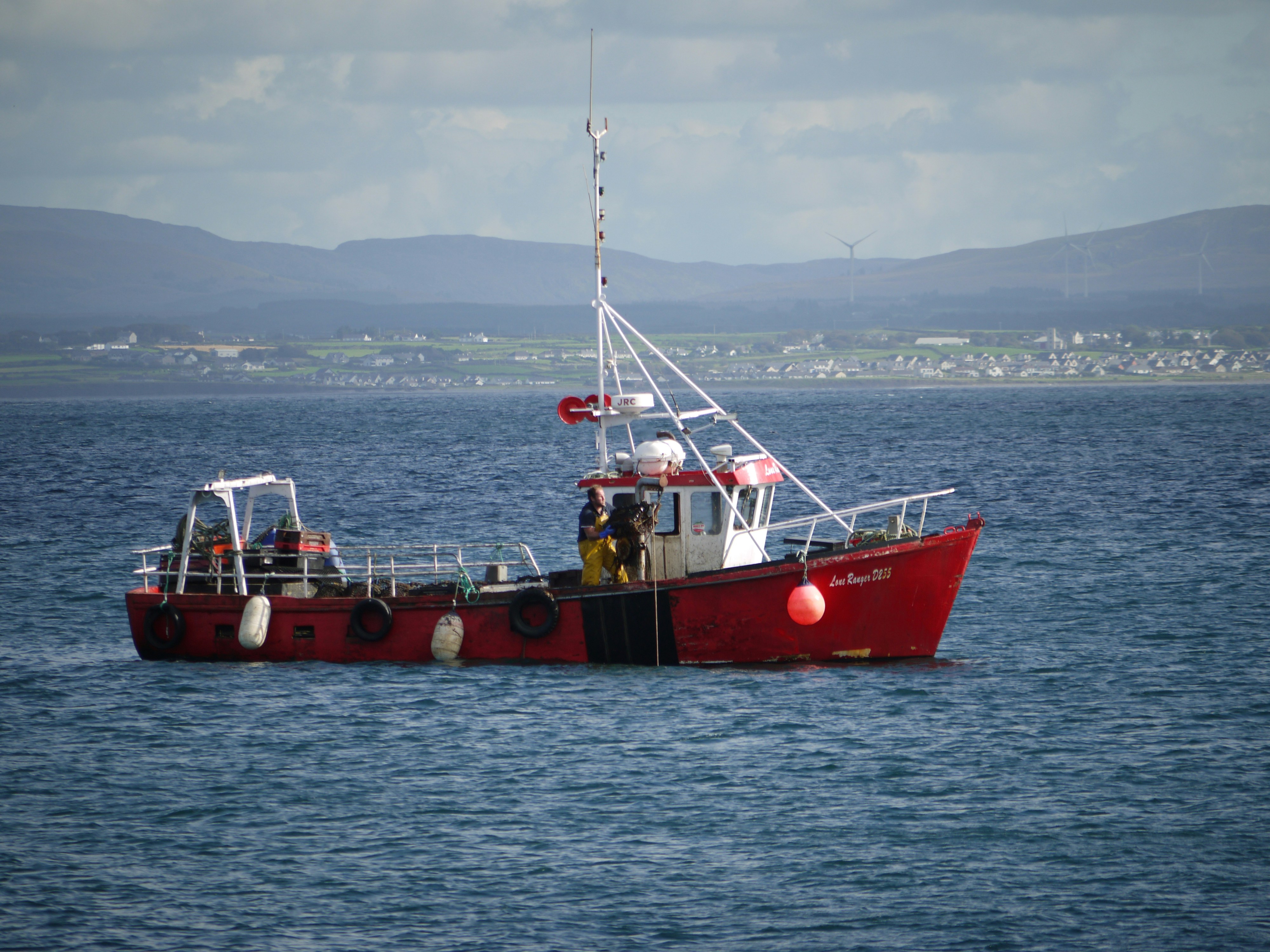 A red boat in the middle of the ocean
