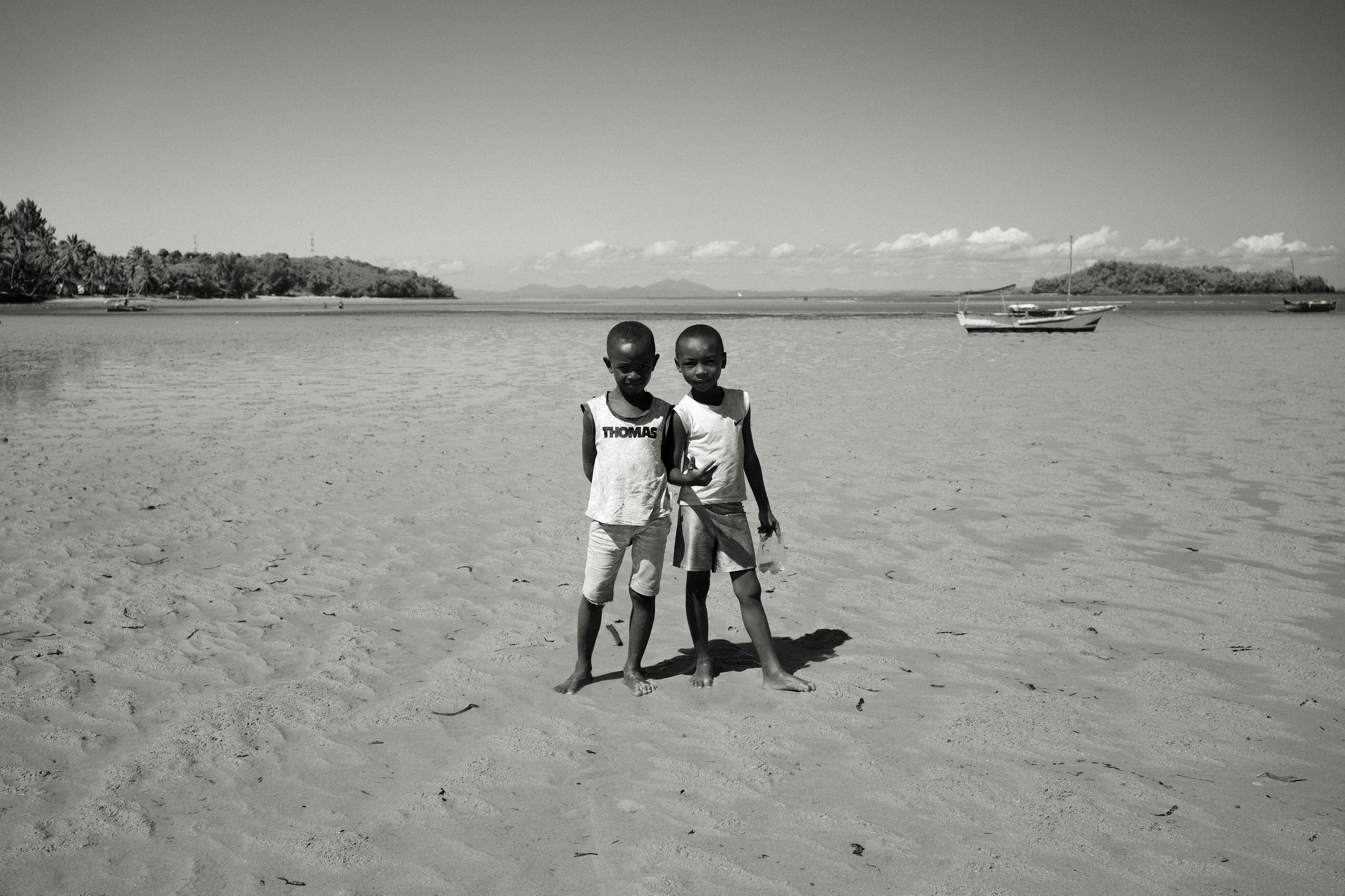 A couple of people that are standing in the sand photo – Free ...