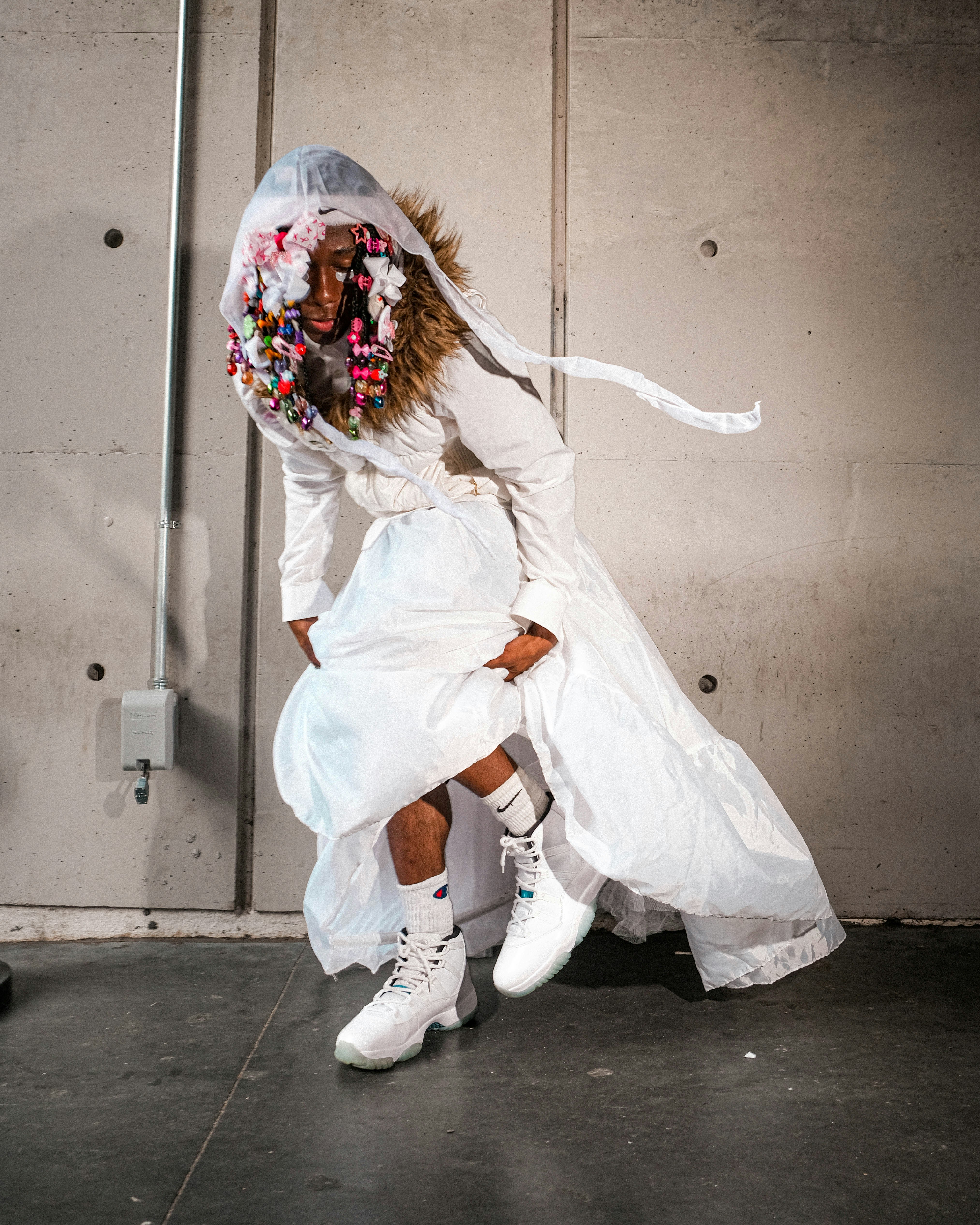 White-dress dancer twists through a stark industrial space