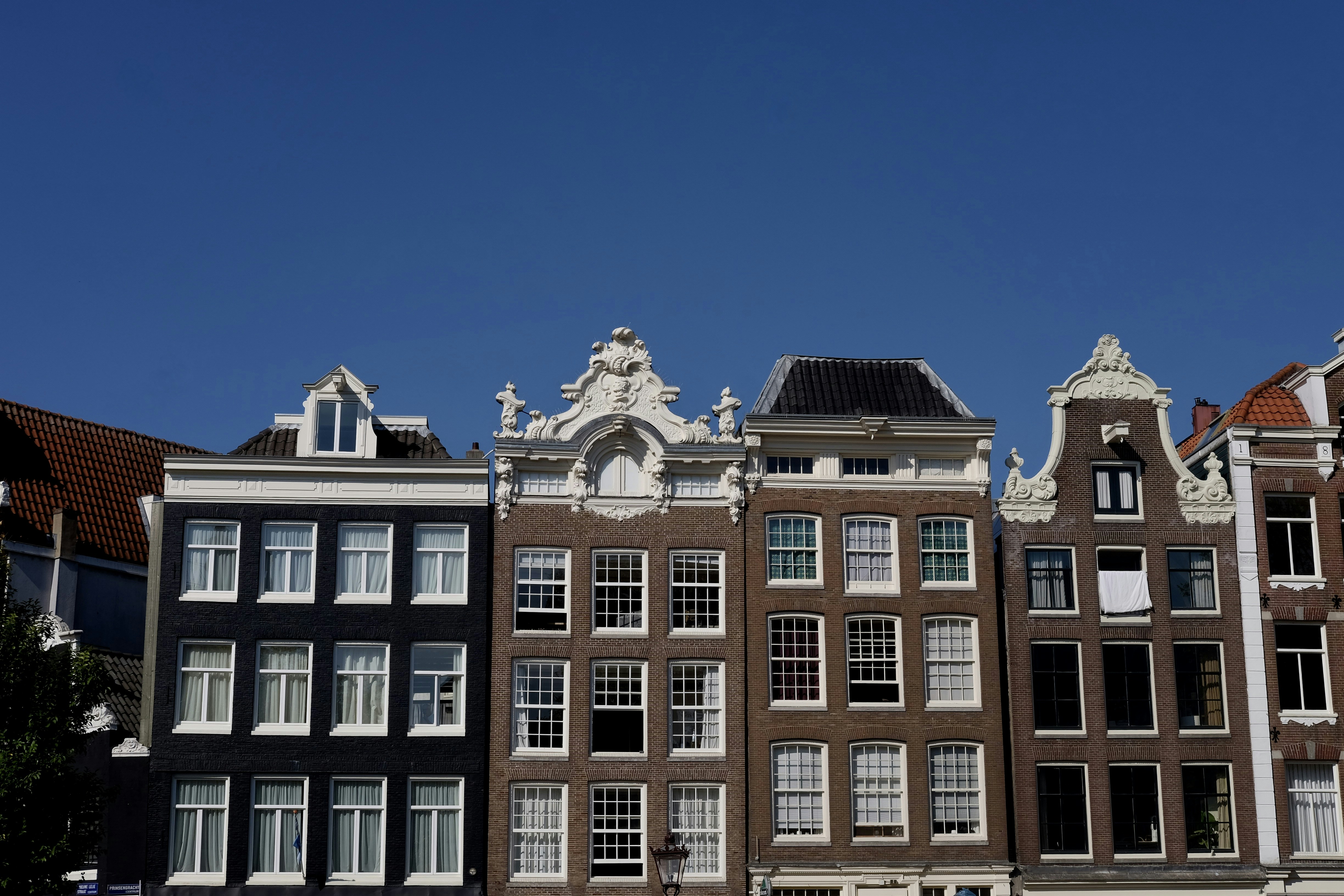A row of buildings on a street corner photo – Free Amsterdam Image on ...