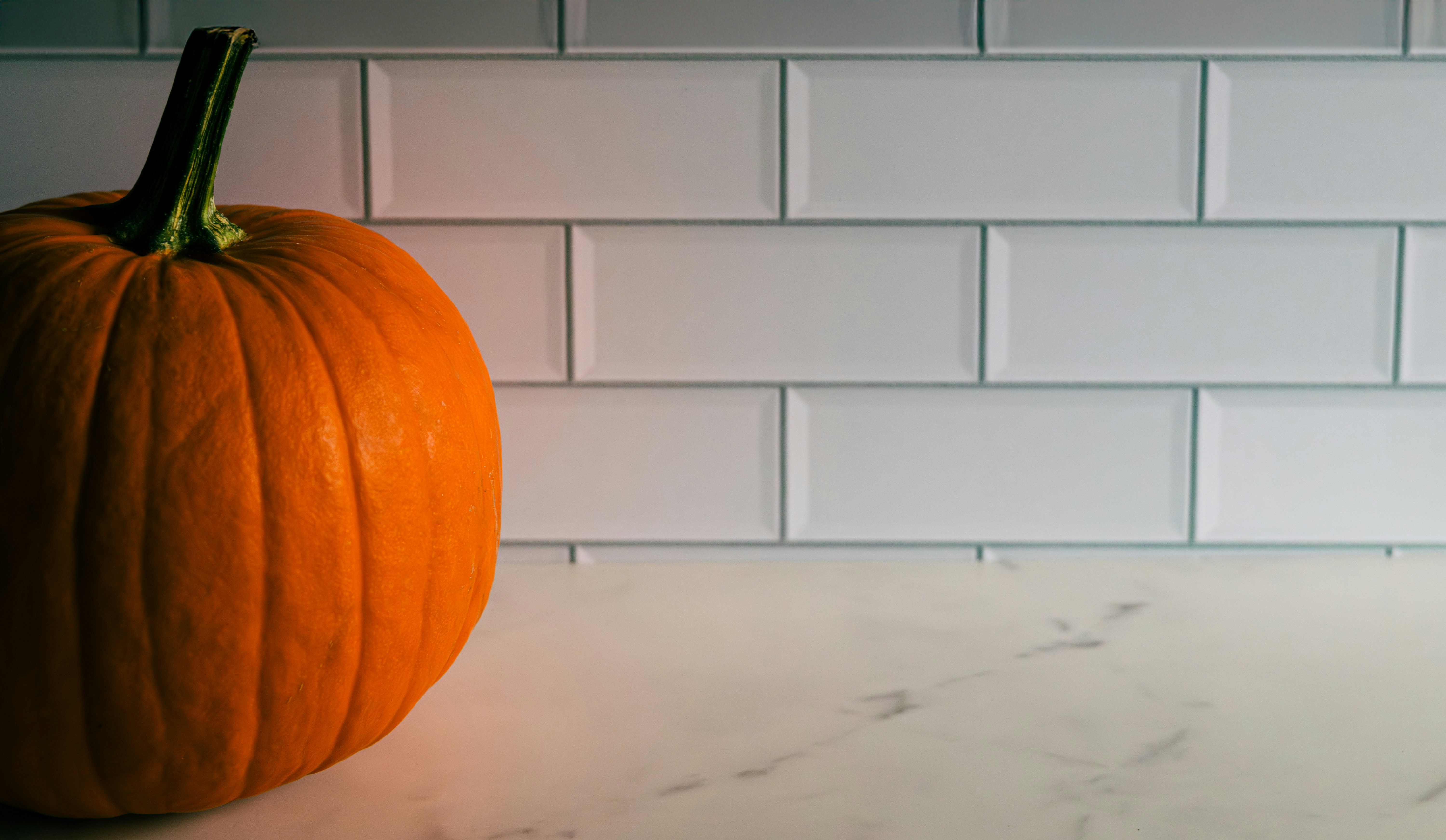 Pumpkin at the Edge: Quiet Kitchen Light on Marble