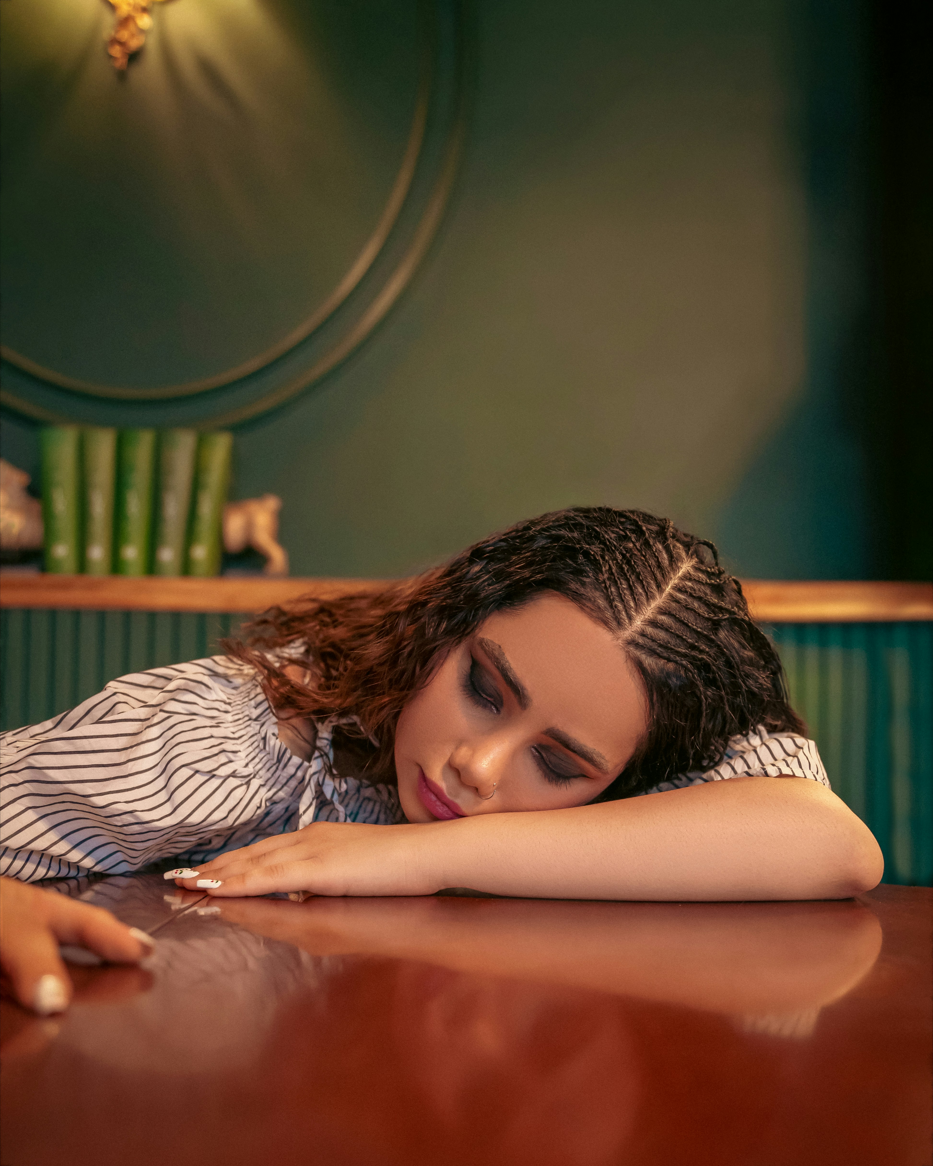 A woman laying her head on a table photo – Free Girl Image on Unsplash