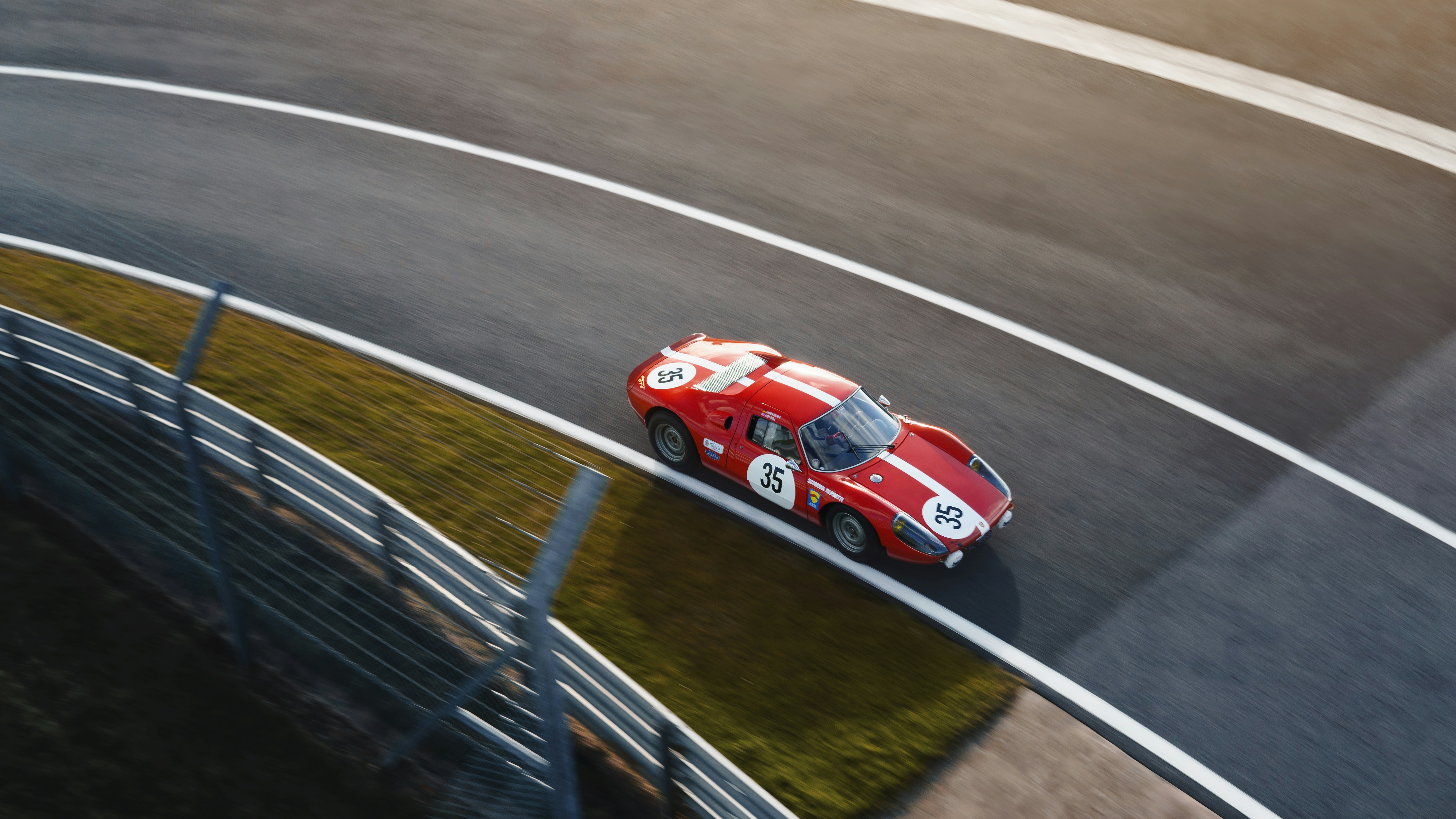 A red sports car driving on a race track photo – Free Silverstone ...