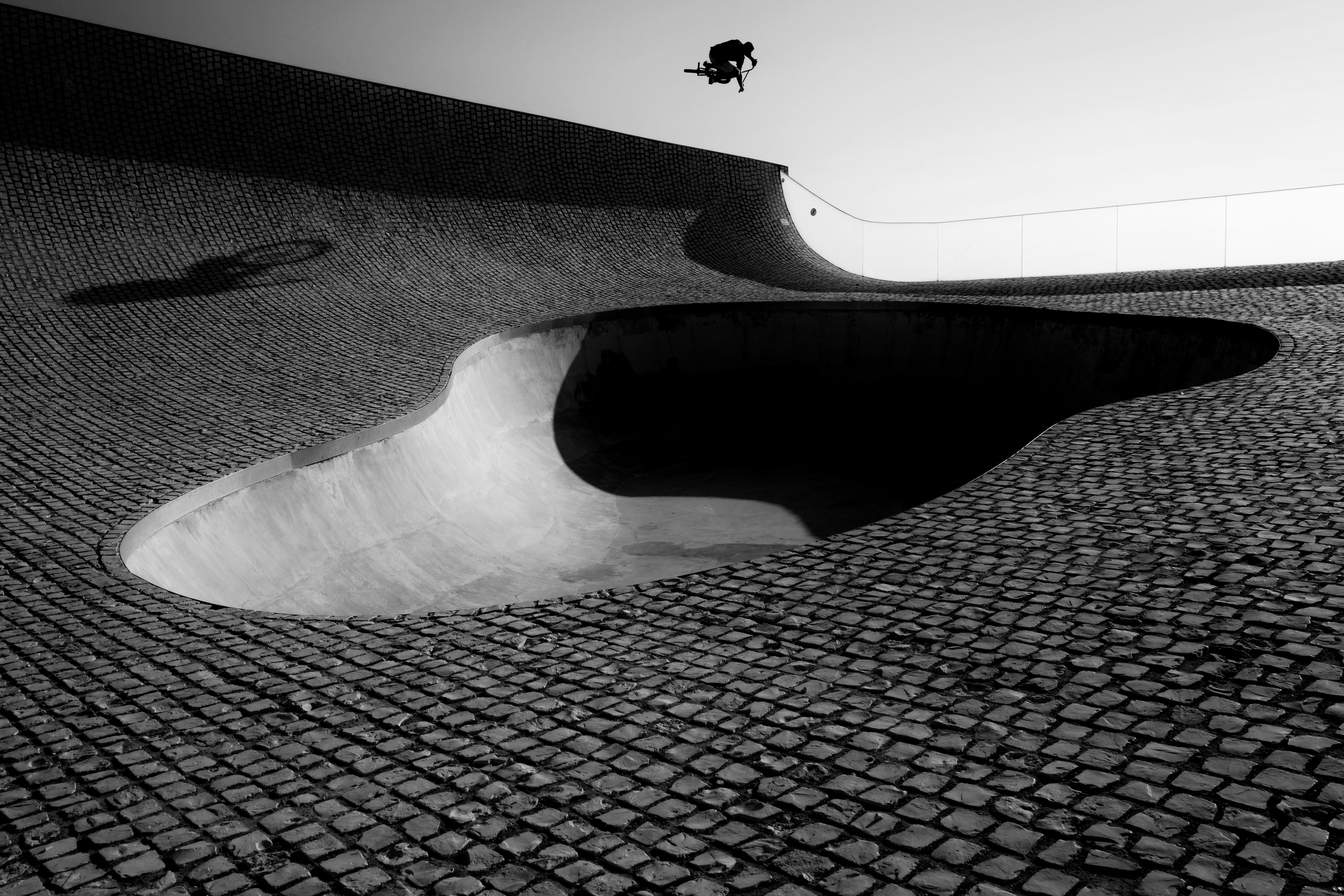 Midair over the Pebbled Bowl: A Skateboarder Defies Gravity