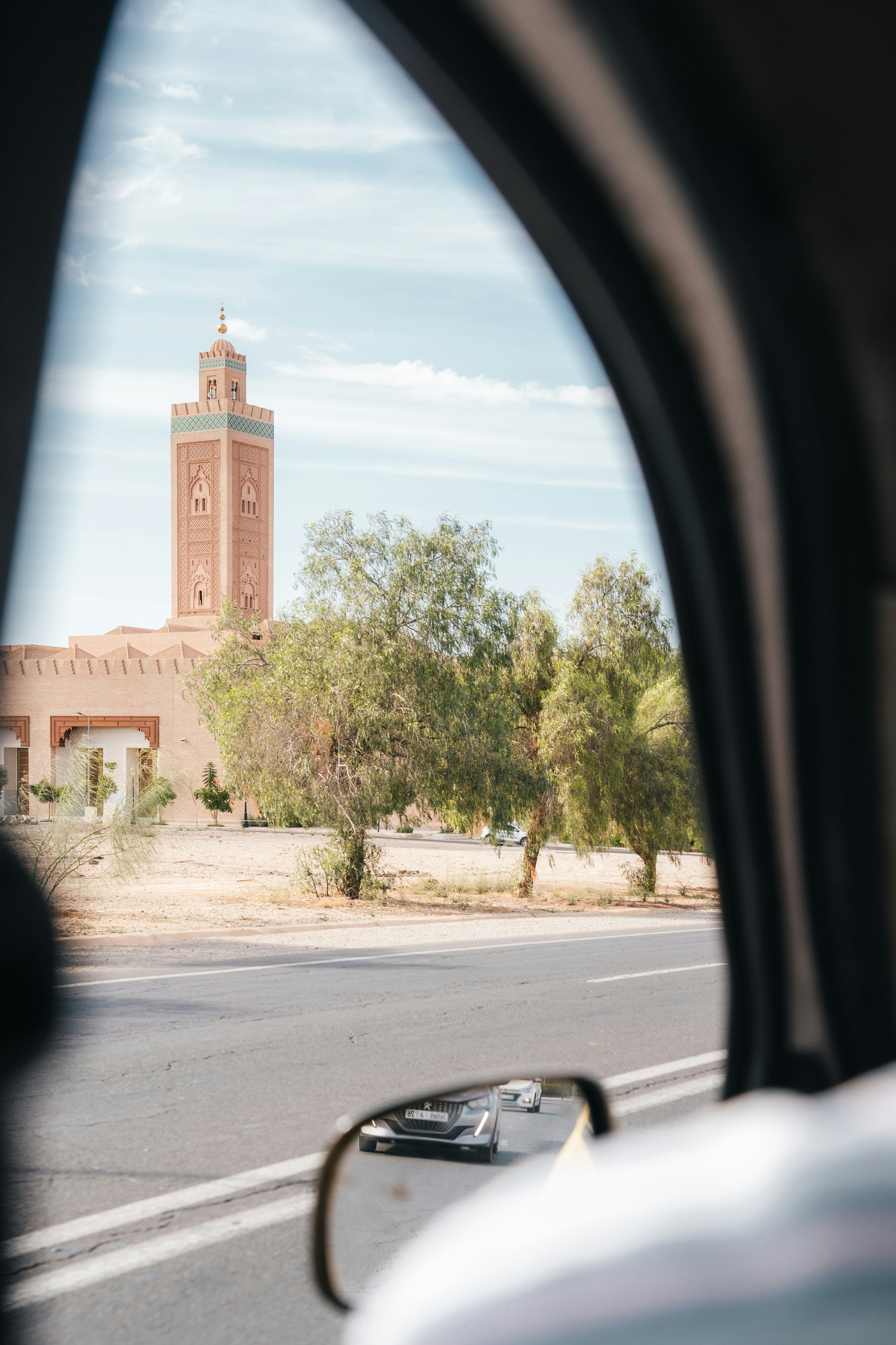 Desert Roadside Minaret Framed by Car Window