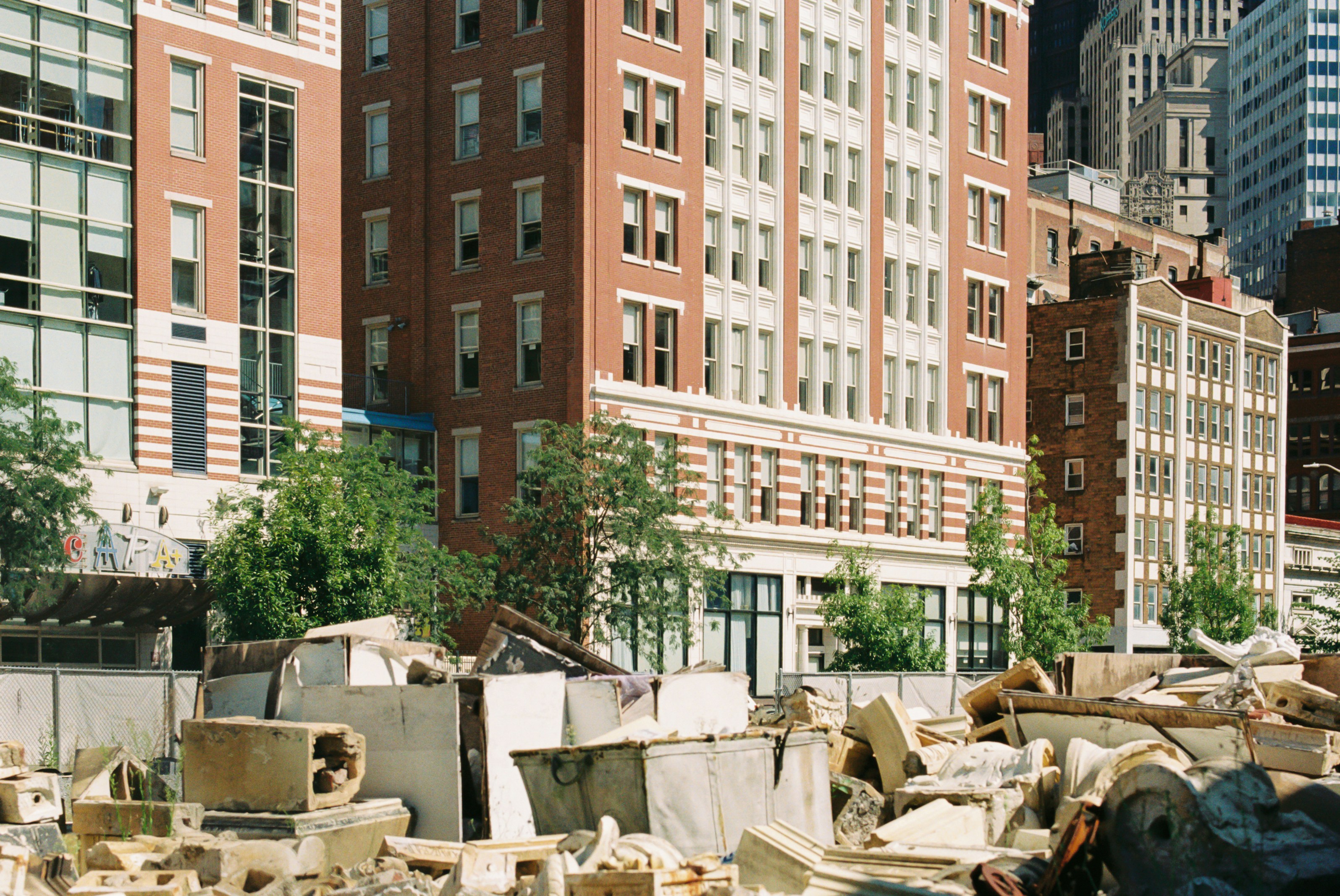 A large pile of junk in front of tall buildings photo – Free Pittsburgh ...