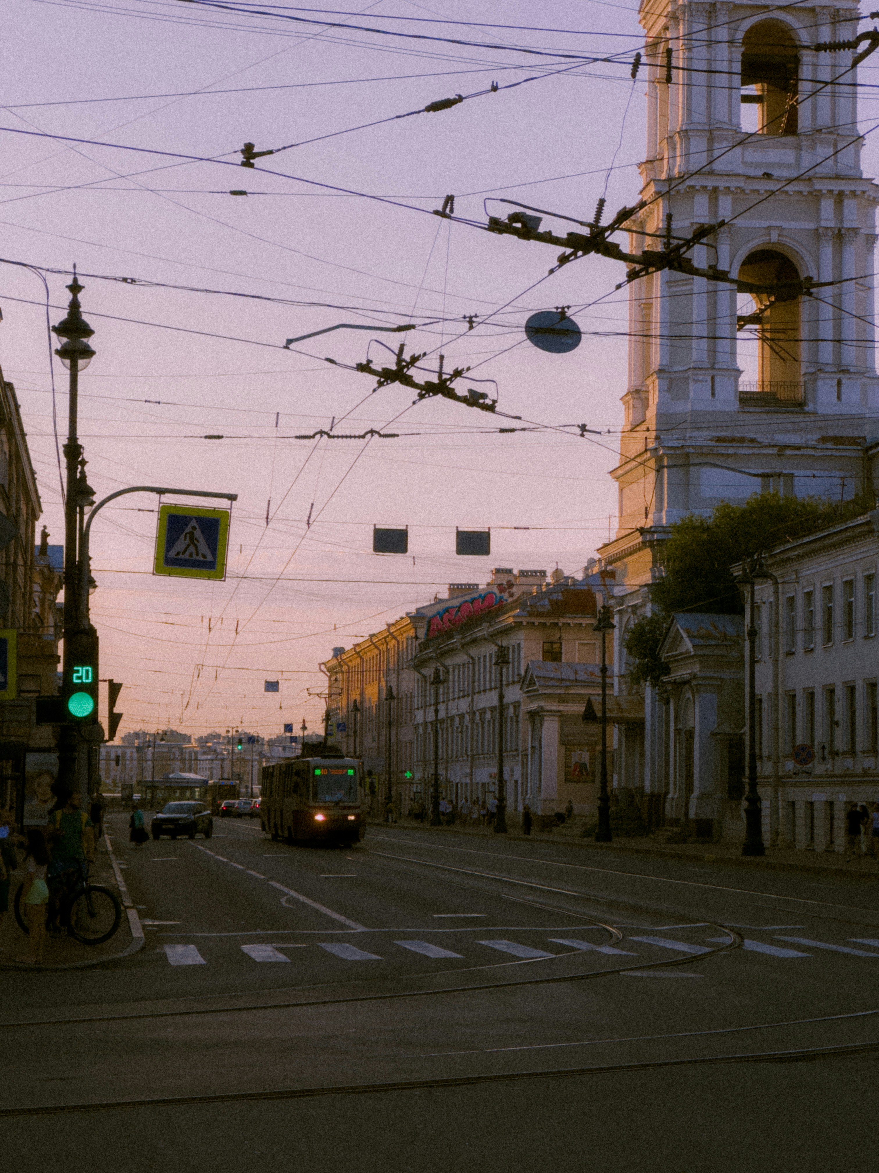 Sunset Streetcar Threading a Wirescape Beneath a Clocktower