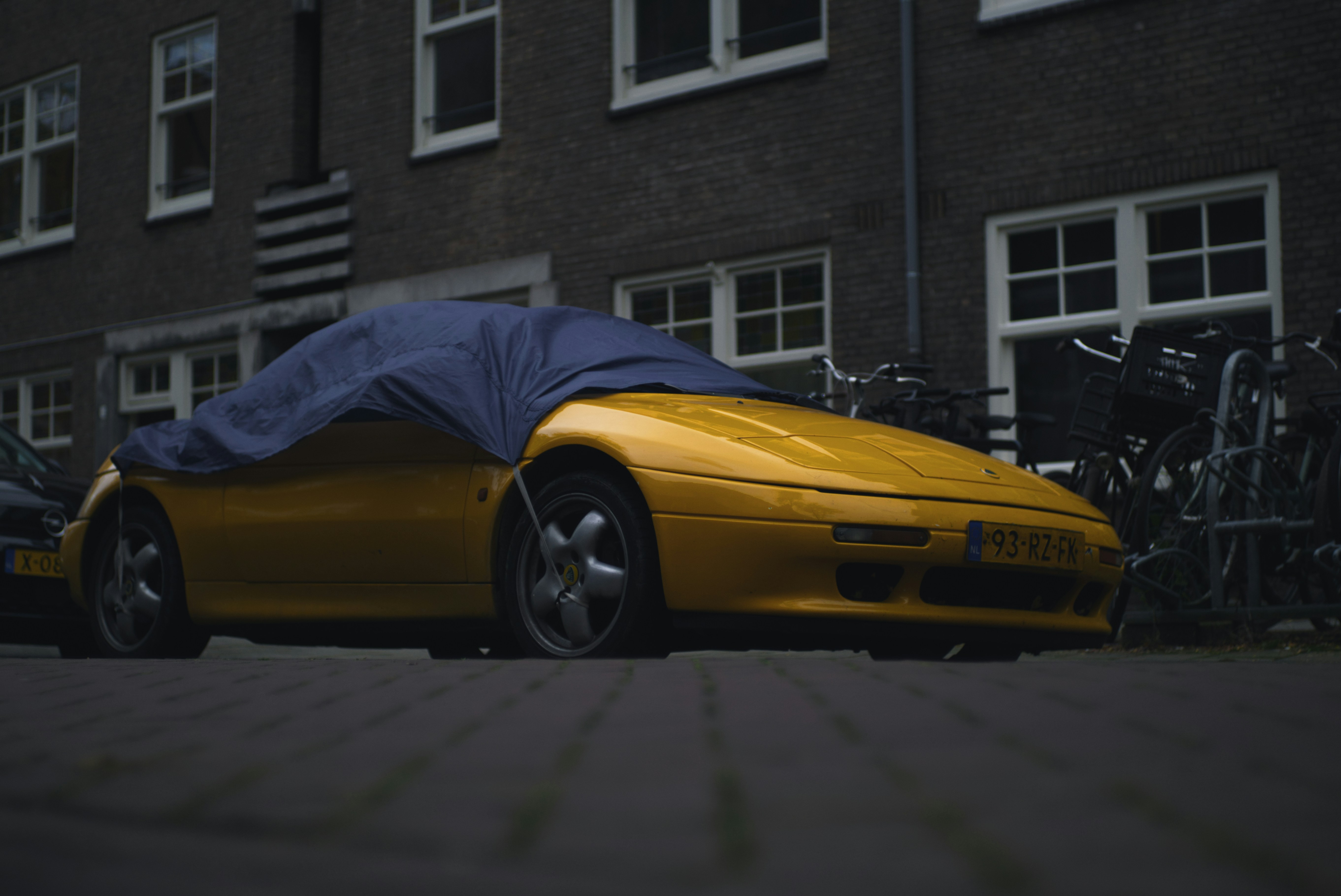 A yellow sports car covered with a blue tarp photo – Free Amsterdam ...