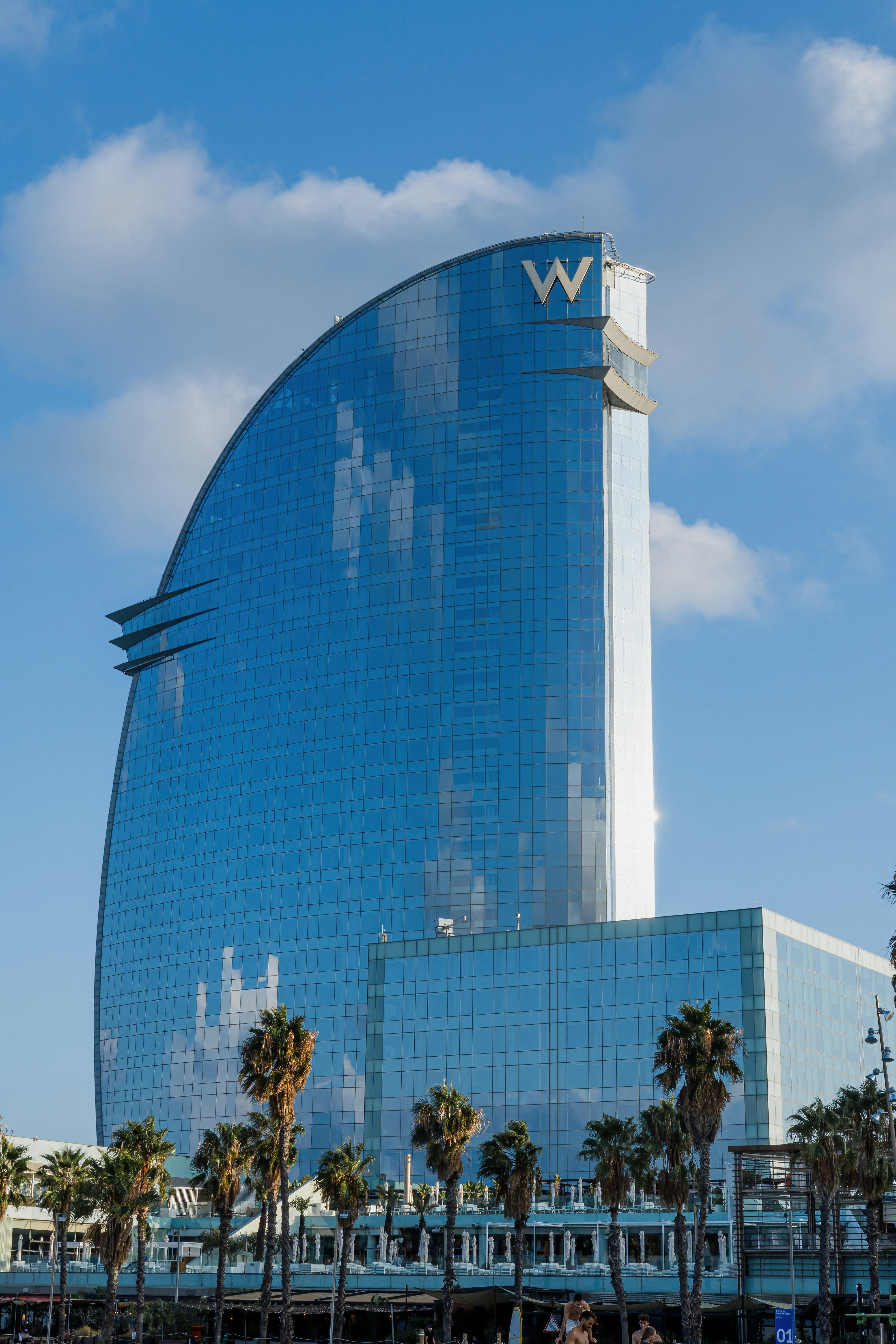 A very tall building with a very tall tower in front of it photo – Free ...