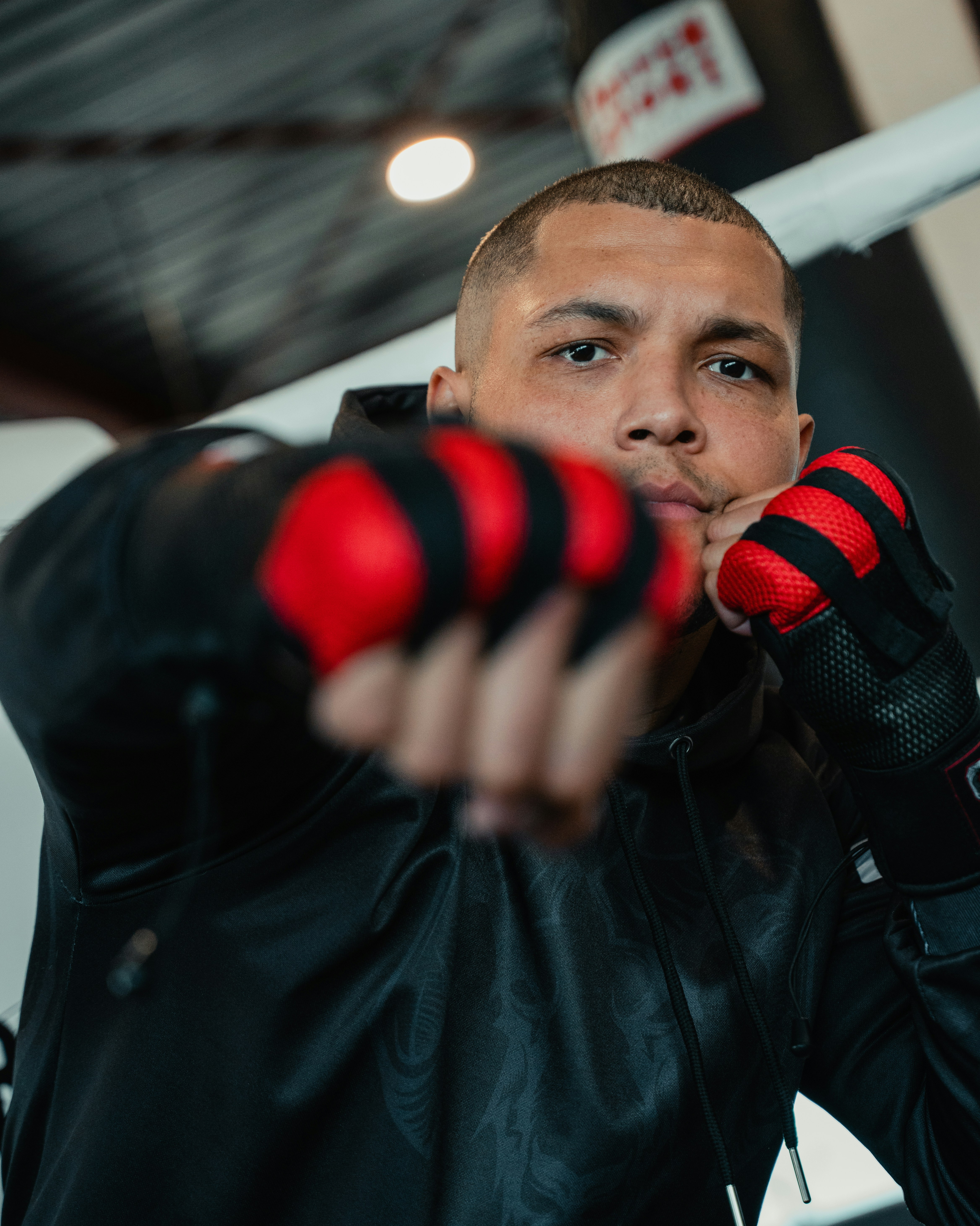 A man in a black leather jacket pointing a finger at the camera photo ...