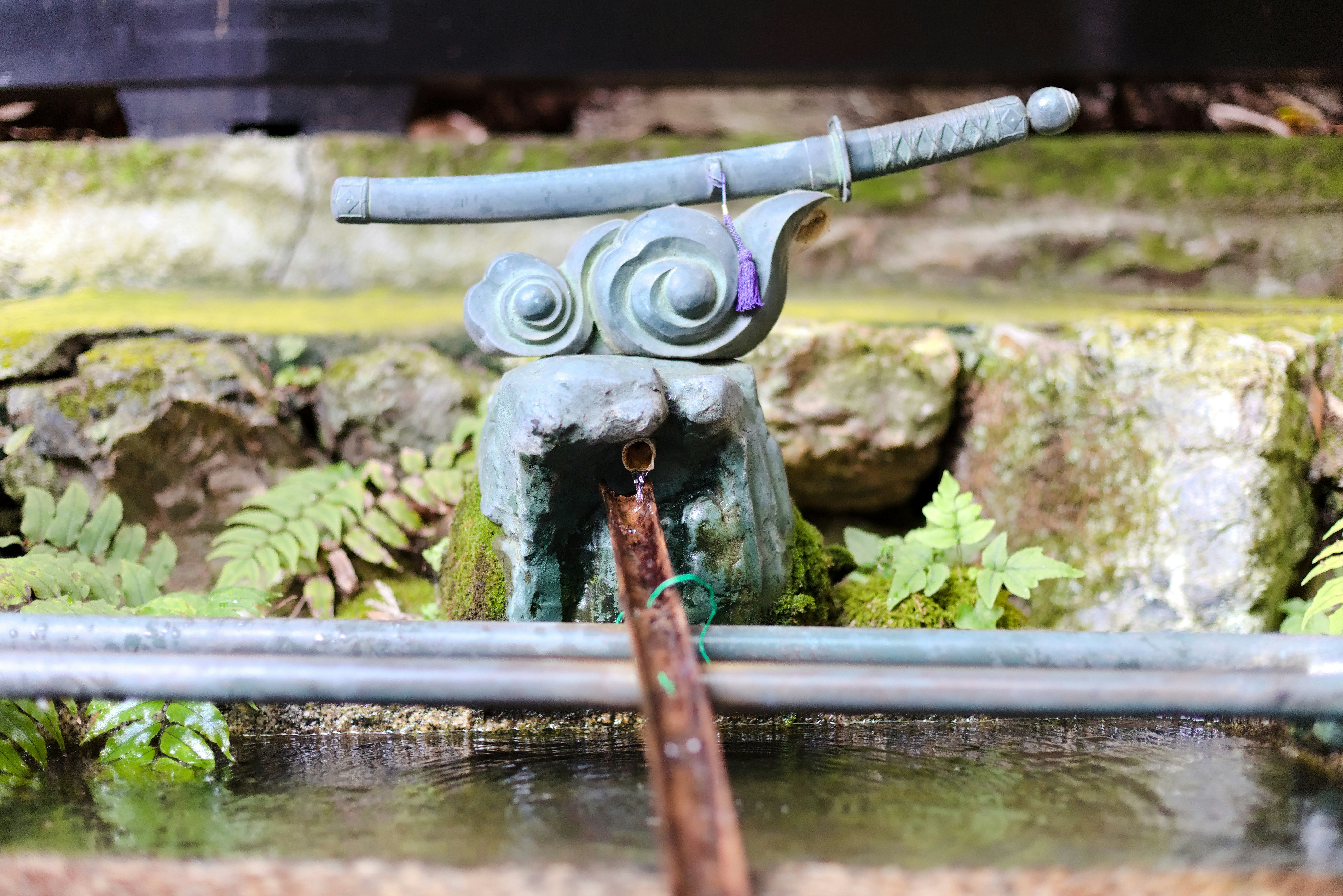 Weathered Garden Tap Framed by Moss and Steel