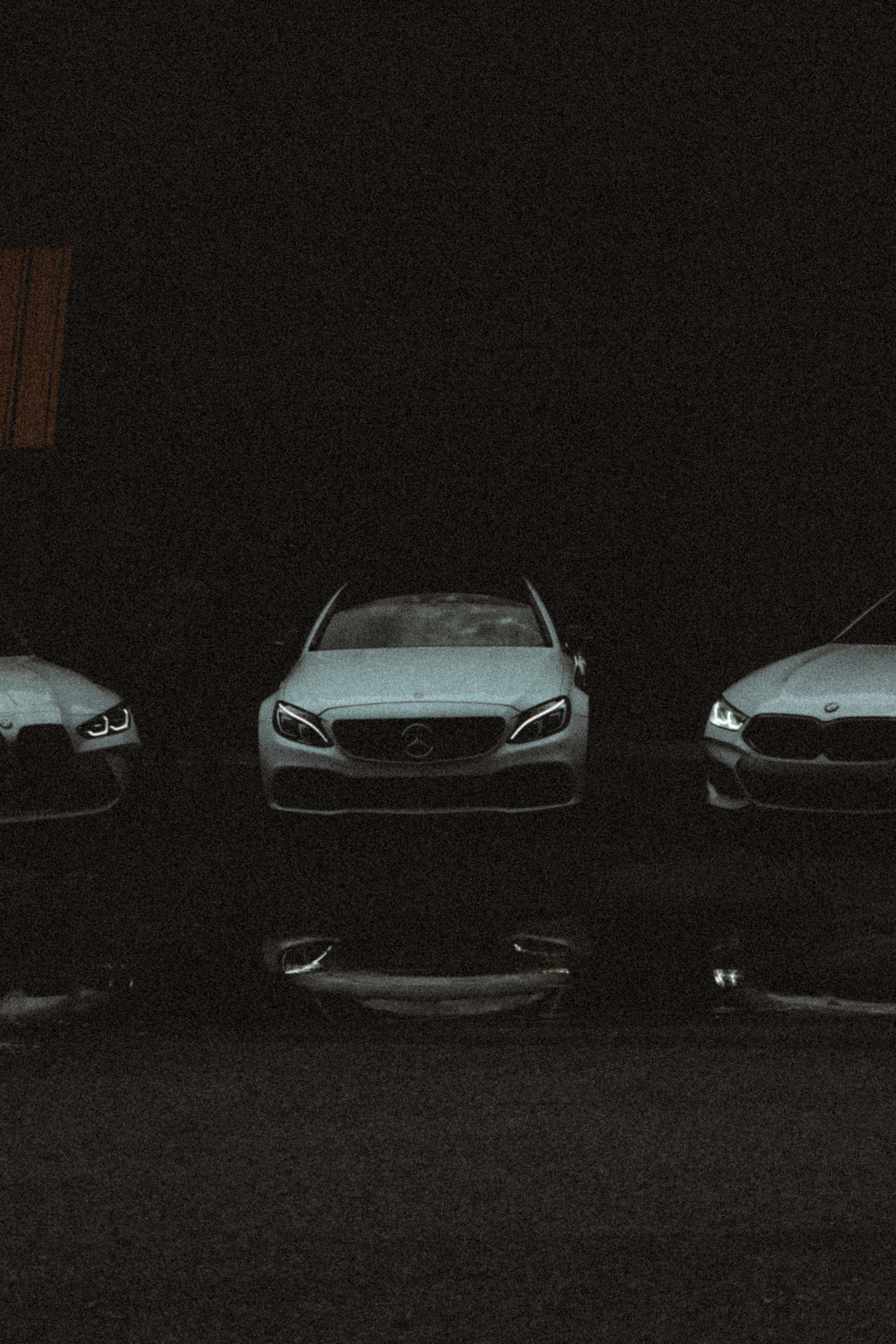 Midnight Row: Three Luxury Cars Beckon in a Dim Garage