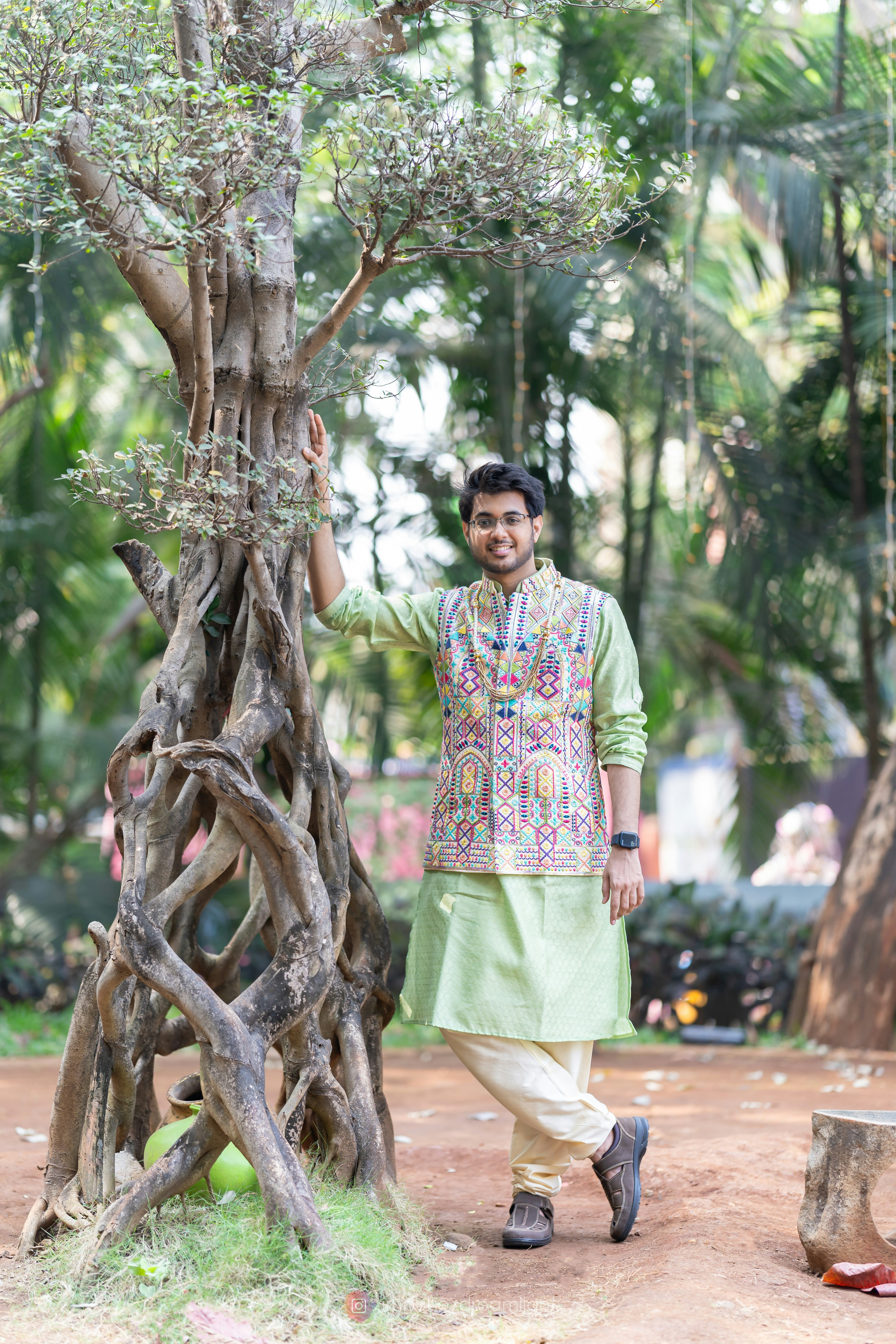 A man standing next to a tree in a park photo – Free Wedding Image on ...