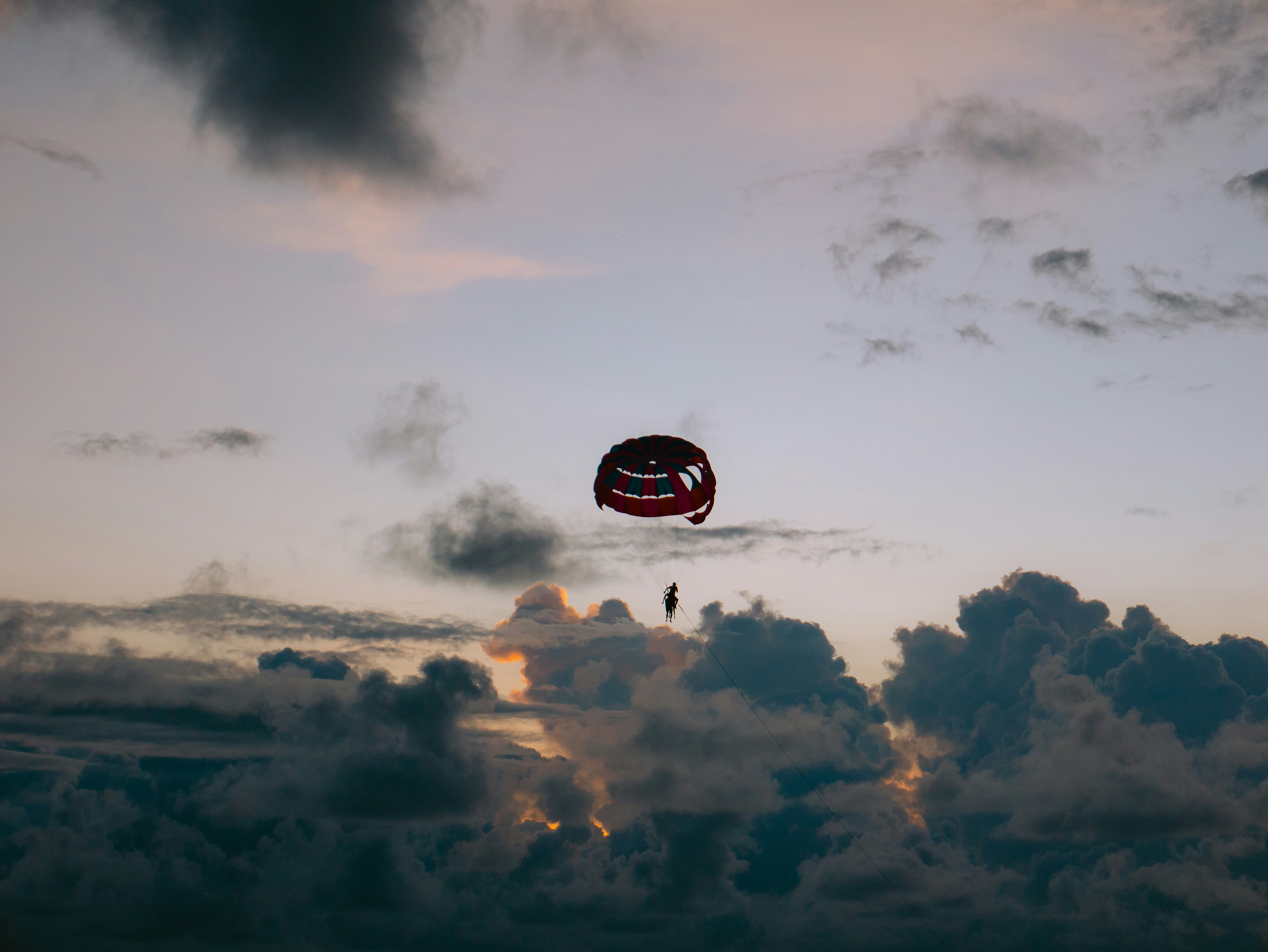 Red Ring of Flight: Paraglider Traces a Dusk-Crowned Cloudscape
