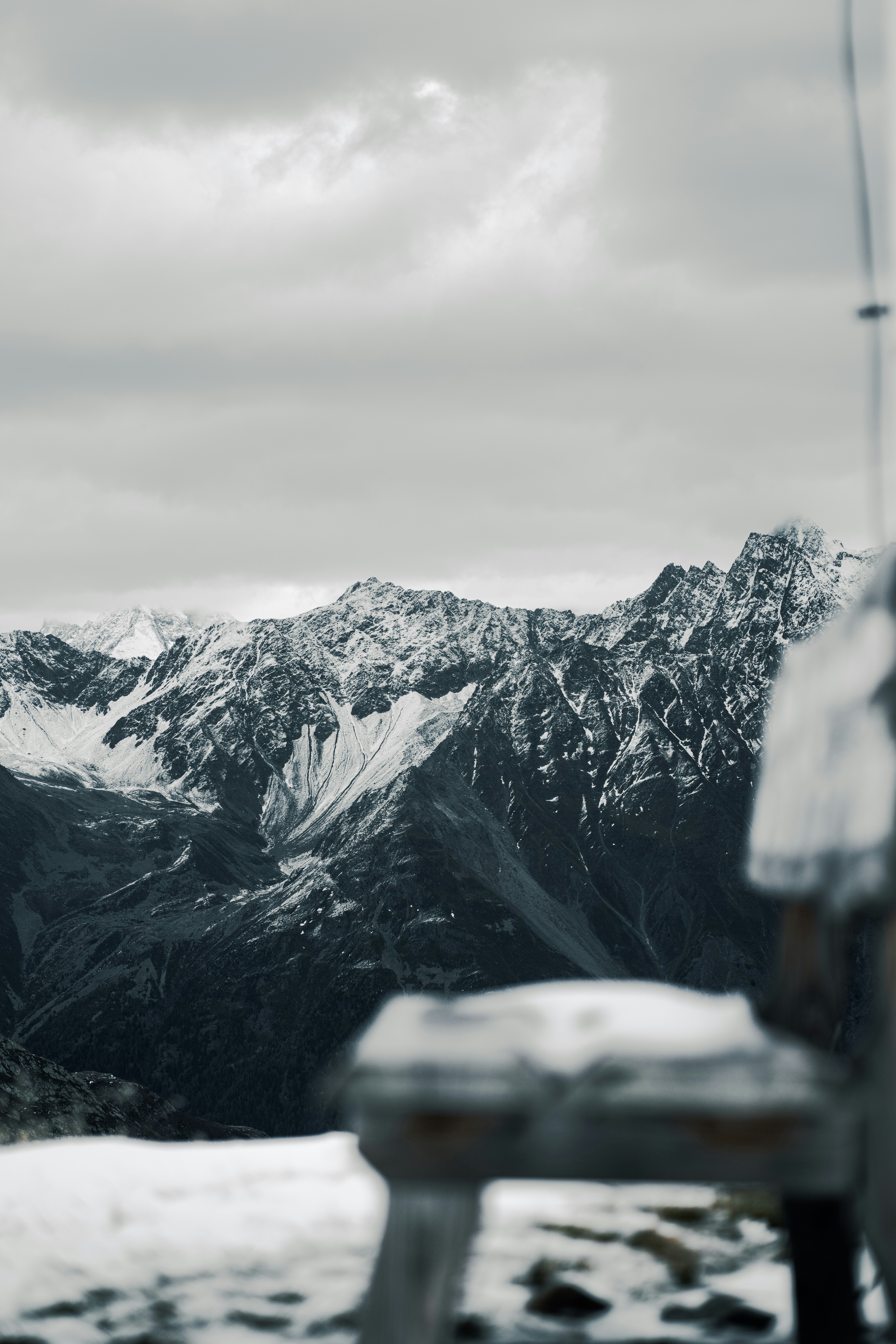 A bench sitting on top of a snow covered slope photo – Free Sölden ...