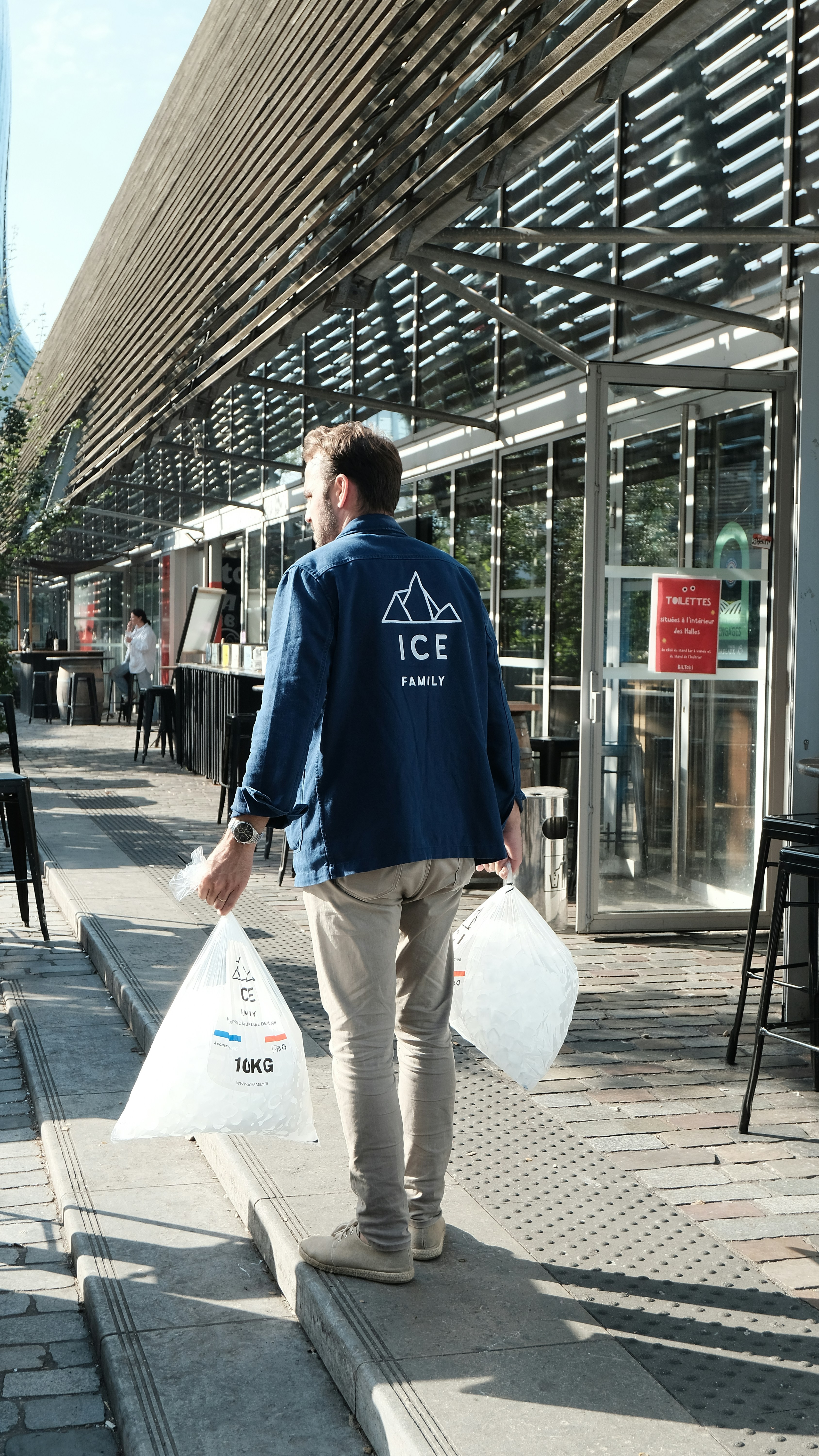 Blue-Jacketed Shopper Departing a Modern storefront