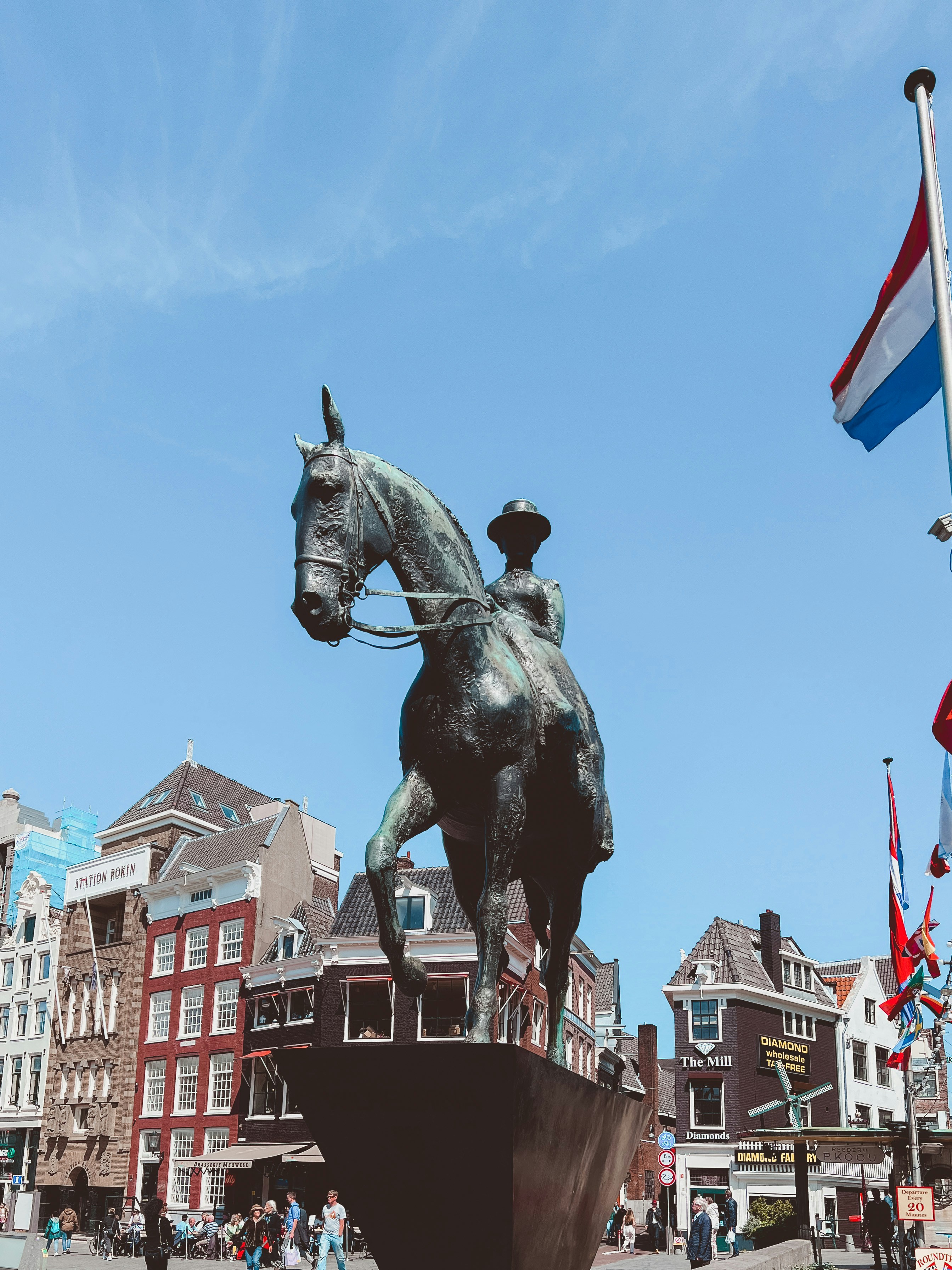 Bronze Equestrian Monument Framed by Dutch Canal-House Facades