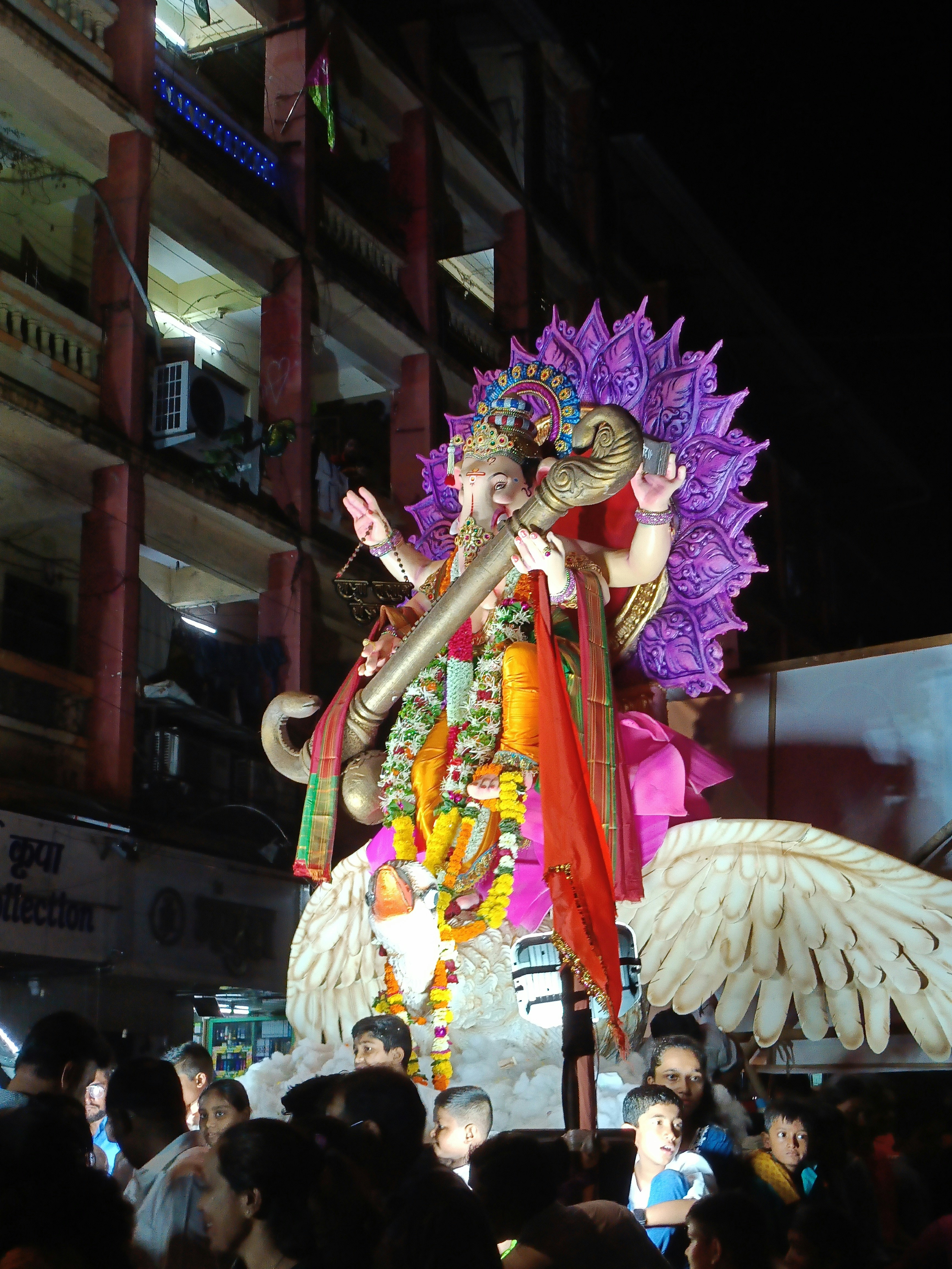 A large statue of a woman with wings on top of a float photo – Free ...