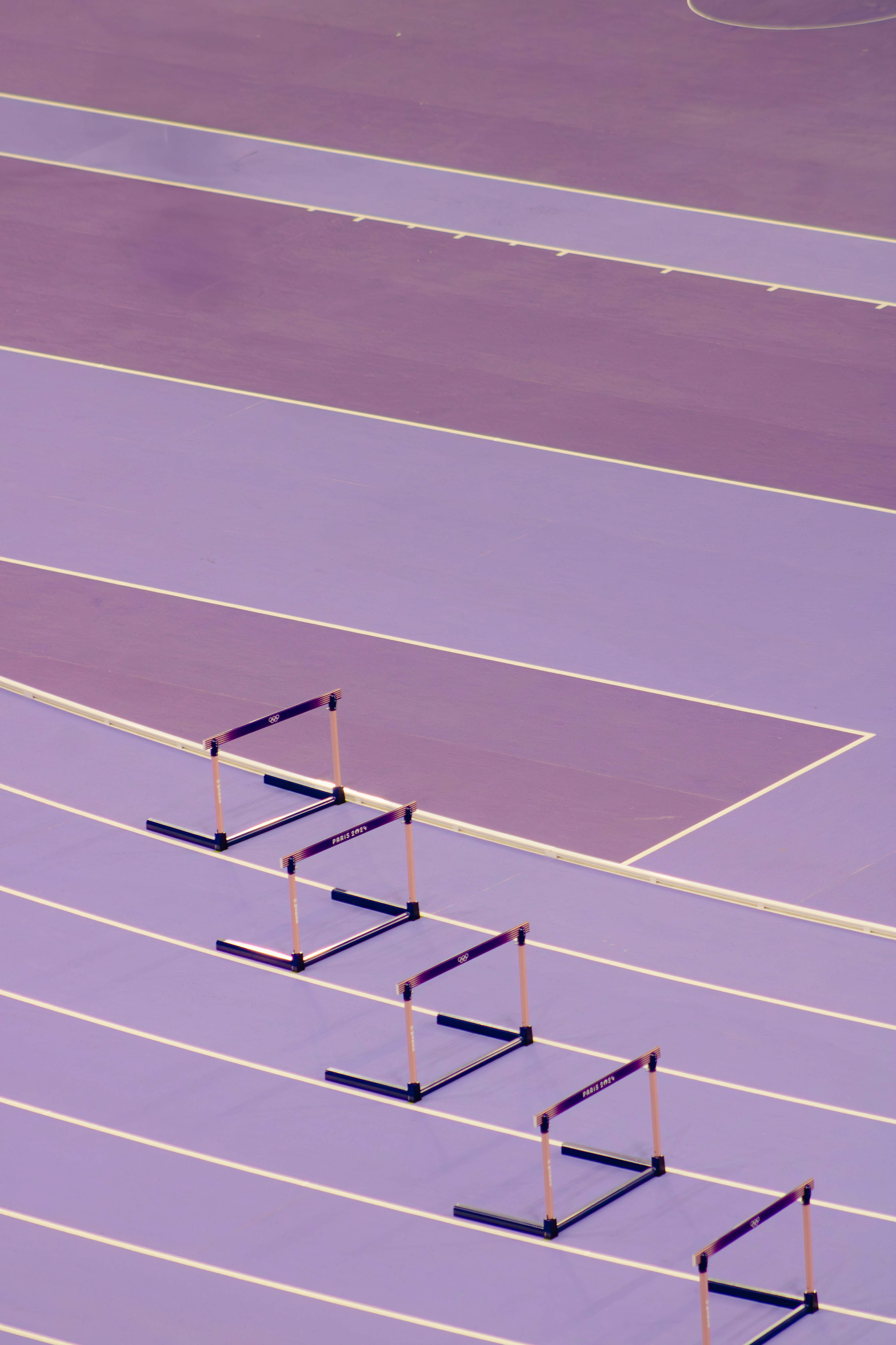 A purple track with a row of poles in the middle of it photo – Free ...