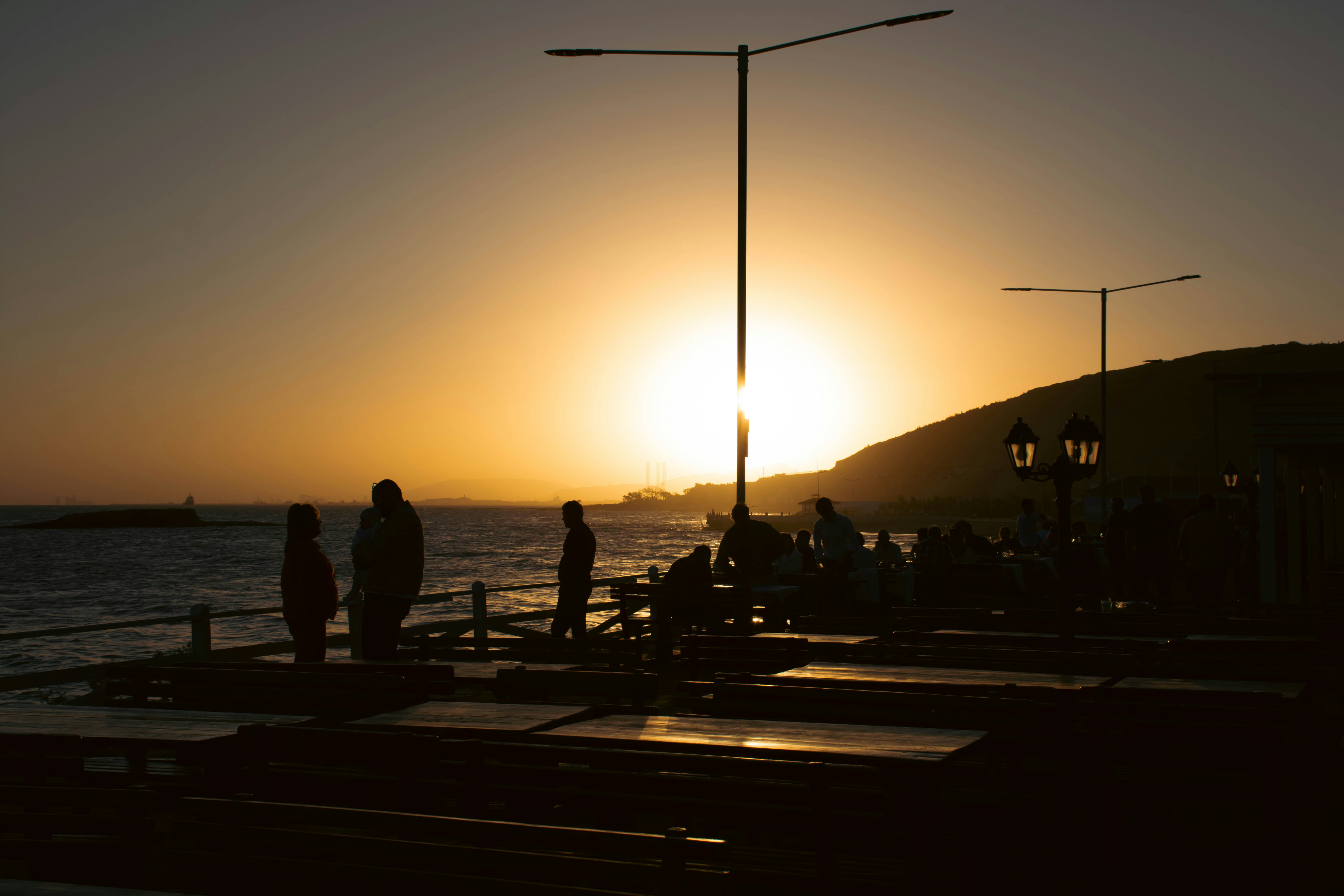 Golden Hour Silhouettes: Evening Figures on the Quiet Pier