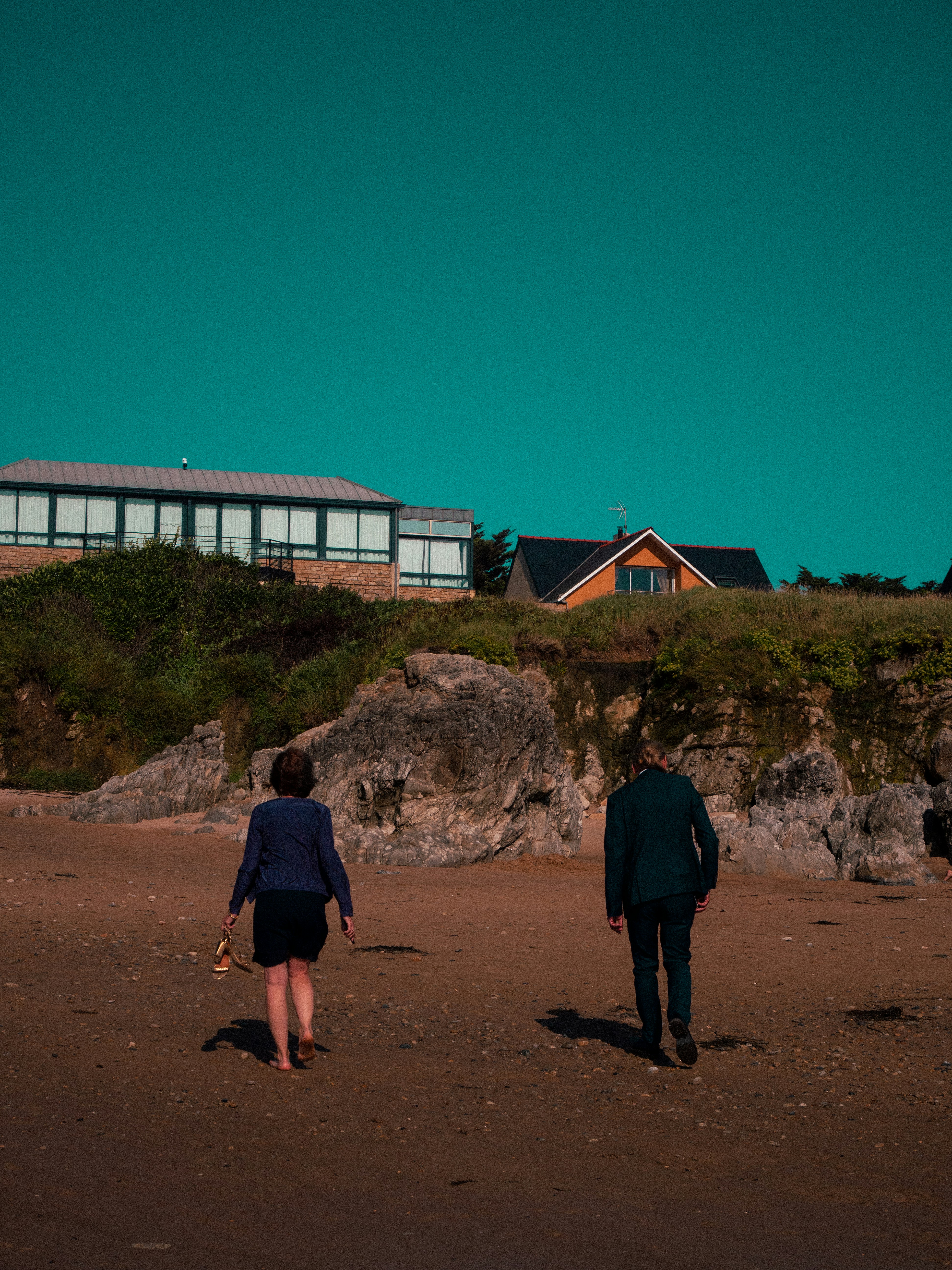 Footpath to the Cliff: Two Figures on a Turquoise Beach