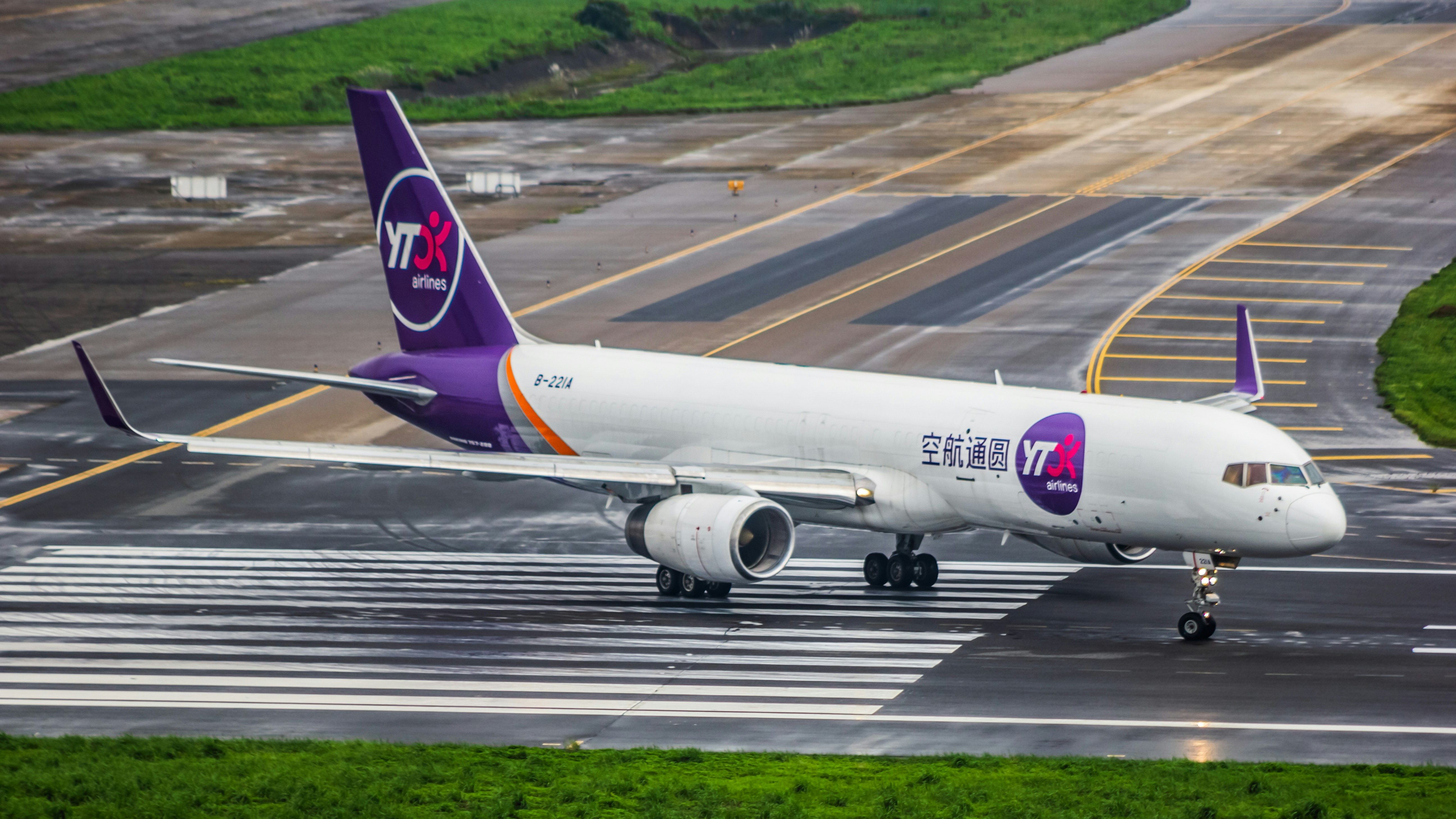 Vibrant Vantage: A VT-ThaiL Flight Touches Down on a Rain-Slicked Runway
