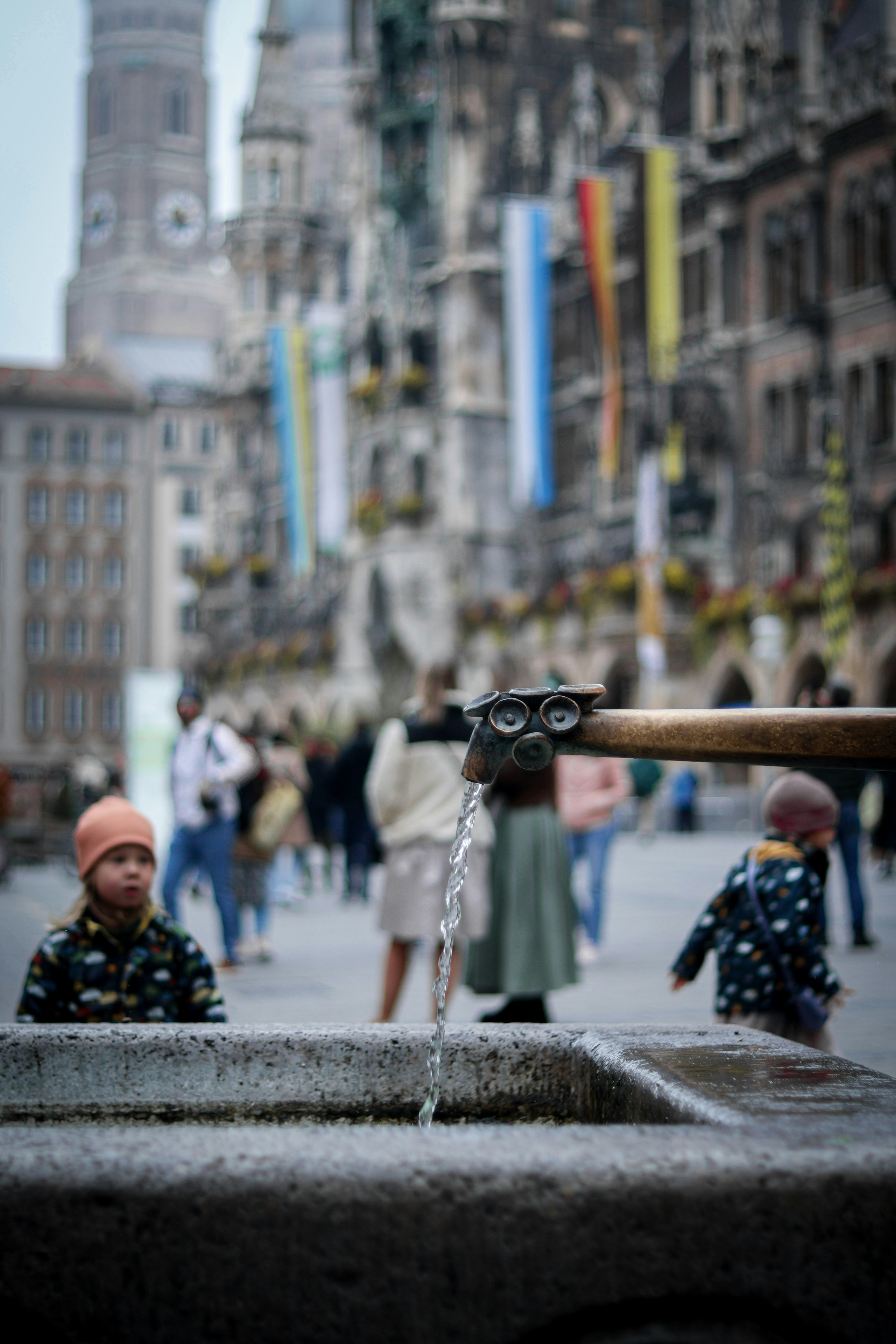 City Square Fountain: Children at Play Beneath a Tangle of Banners