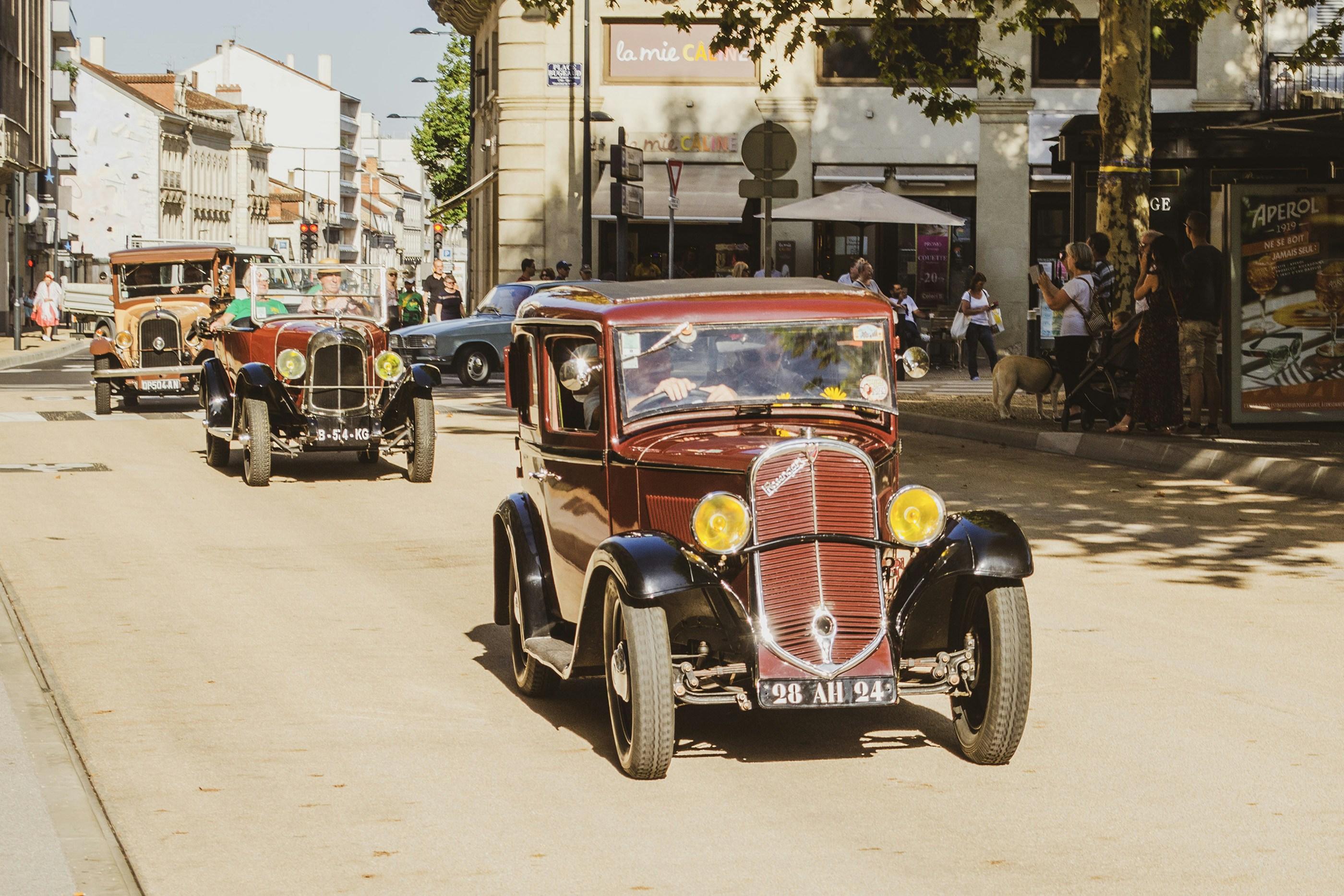 An old time car driving down a street photo – Free Périgueux Image on ...