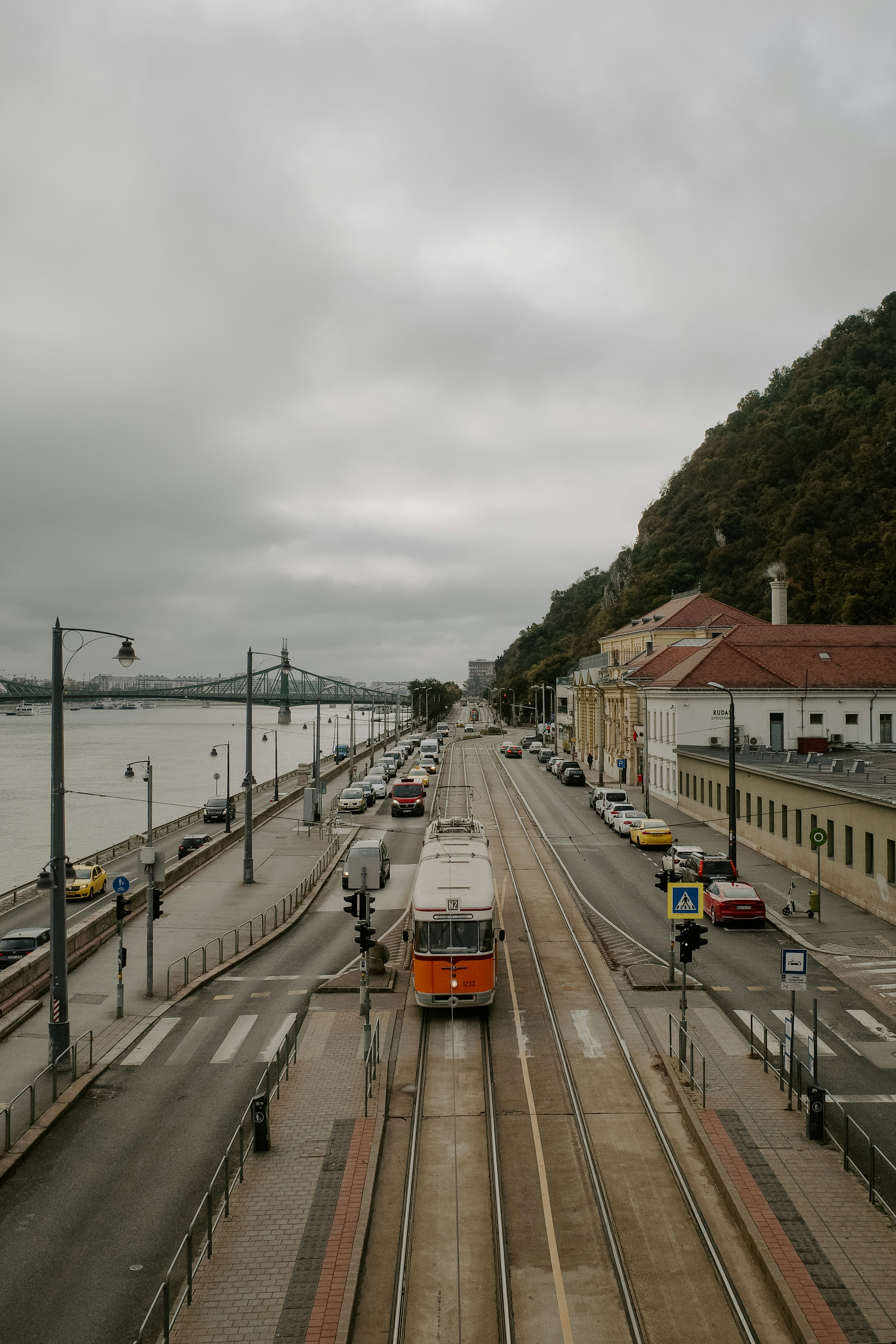 A train traveling down train tracks next to a body of water photo ...