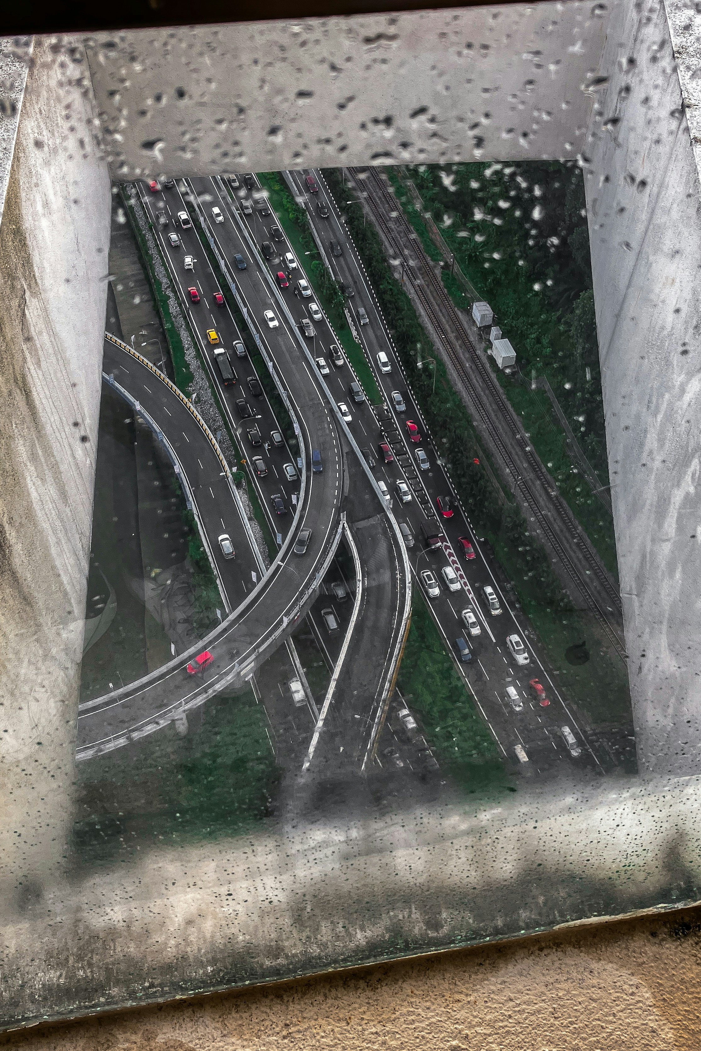 Aerial Tangle: Rain-Dusted Interchange Woven Through the City
