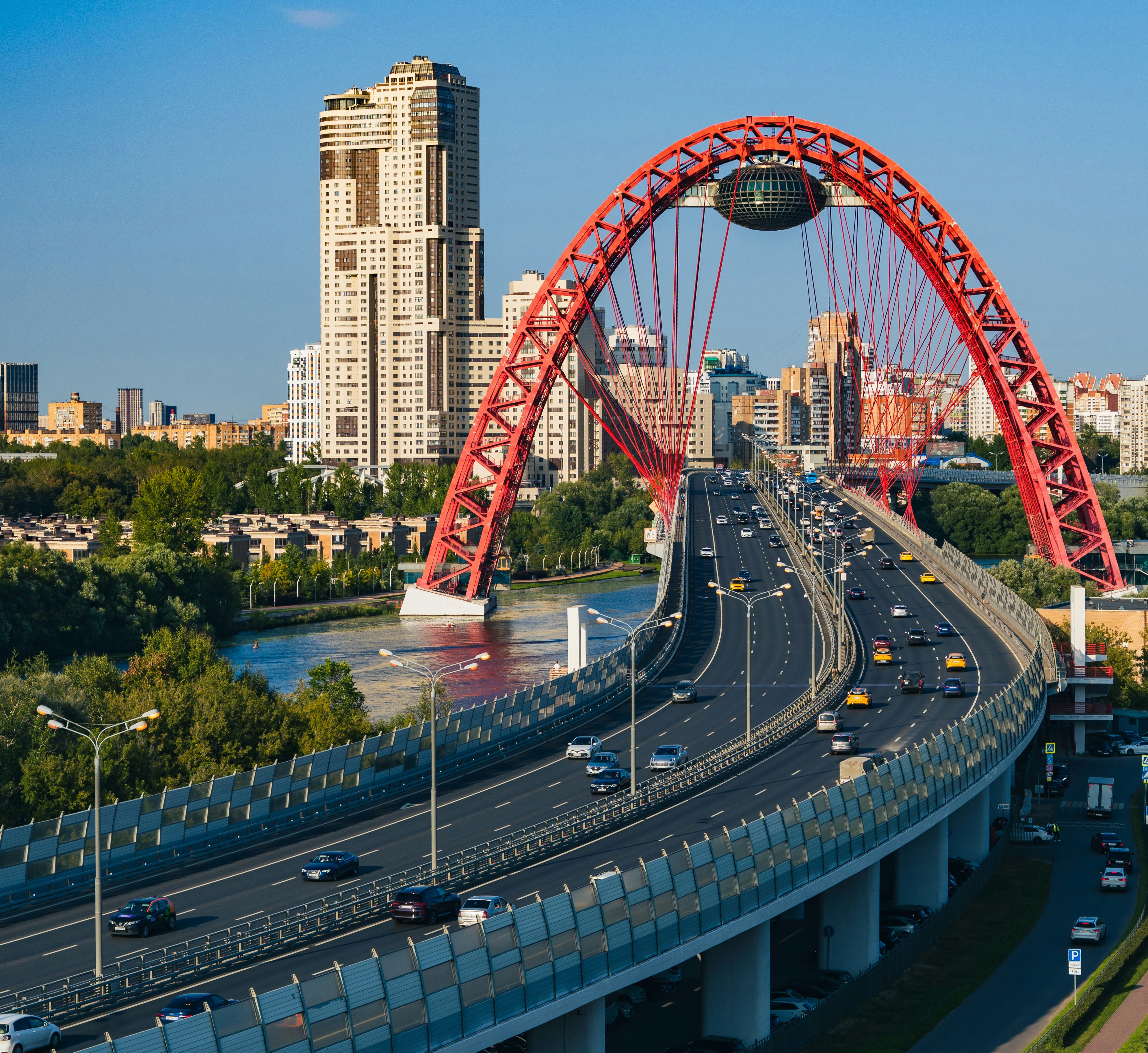 A large red bridge over a city street photo – Free Car Image on Unsplash