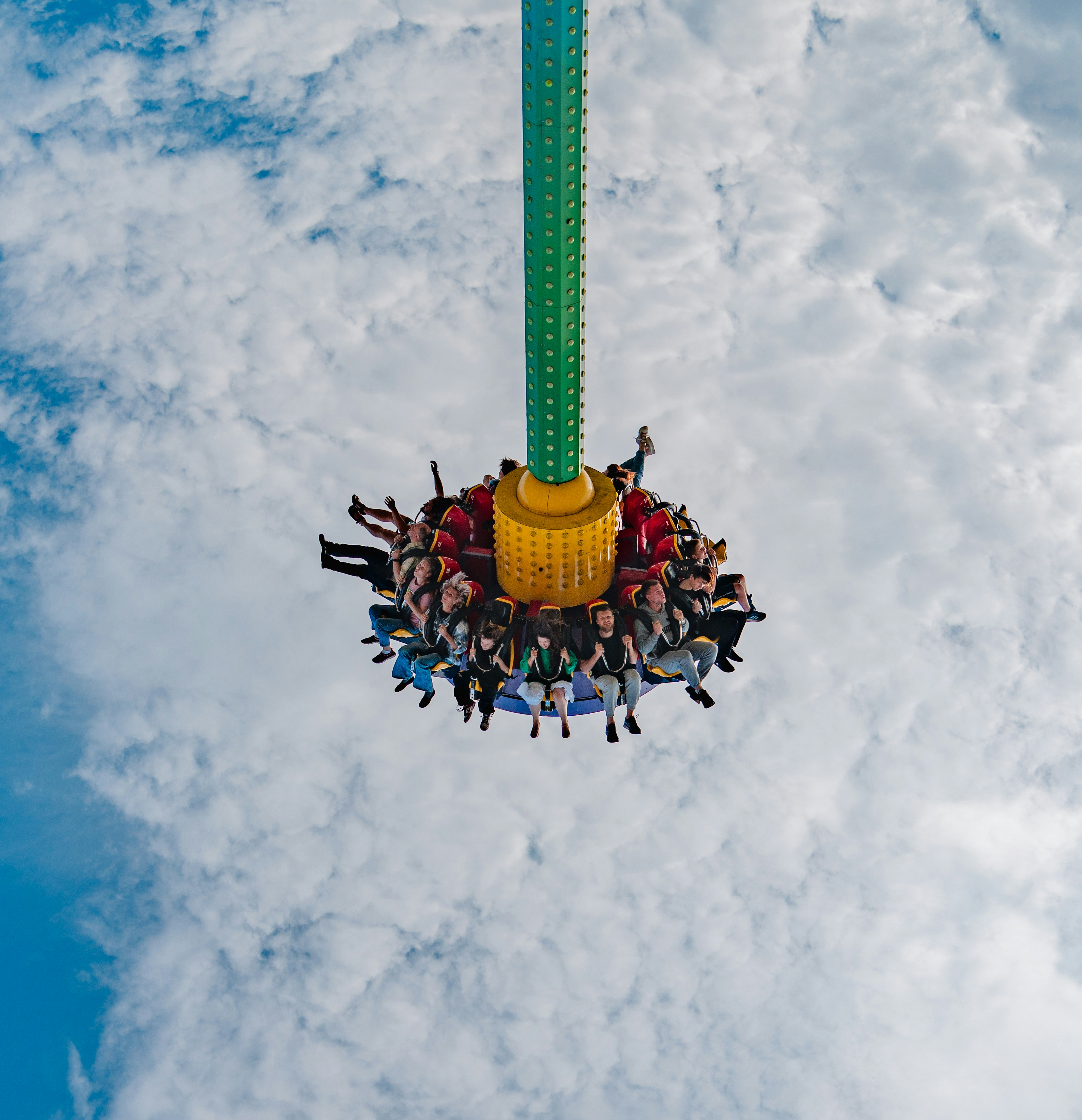 Green Spine, Yellow Hub: Aerial Ring of Riders on a Skyward Swing