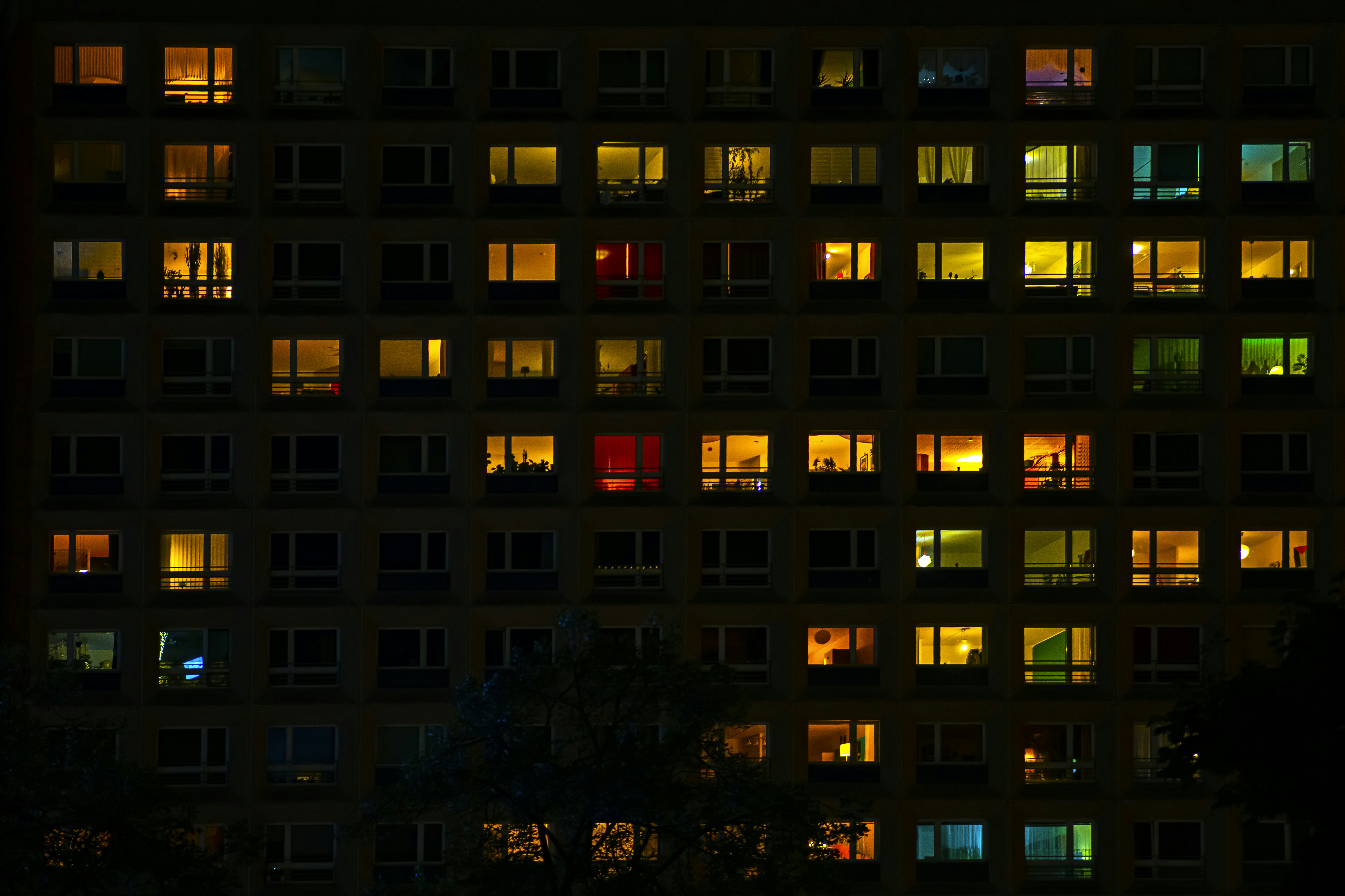 A building with many windows lit up at night photo – Free Berlin Image ...